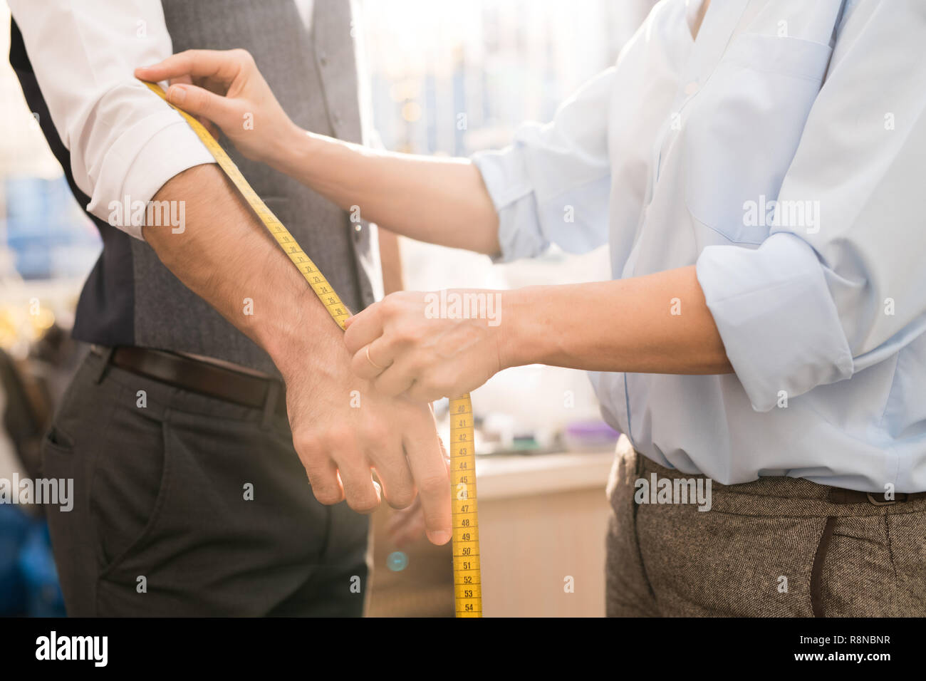 Tailor measuring client close hi-res stock photography and images - Alamy