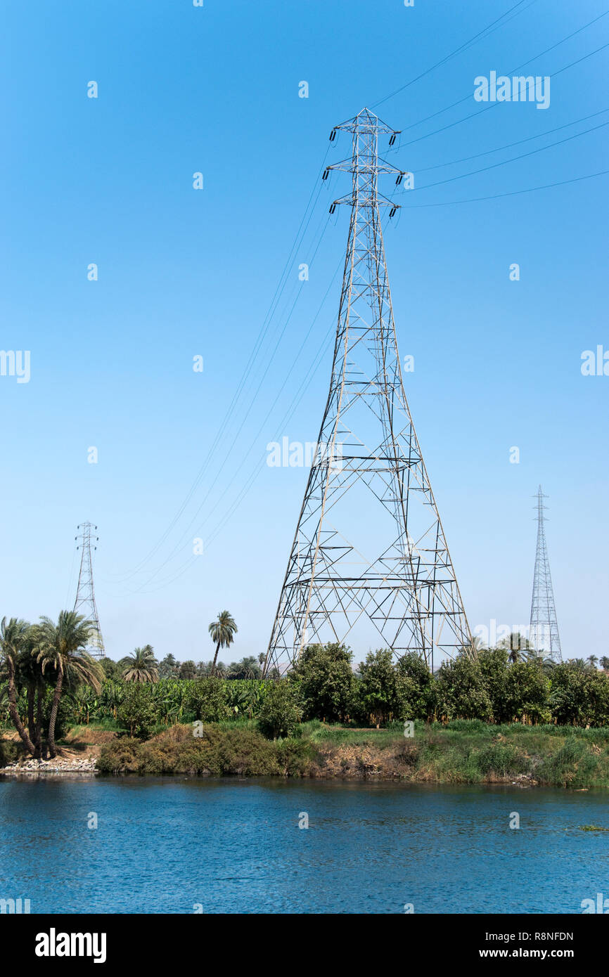 High voltage electrical power lines on tall towers pass over the Nile ...