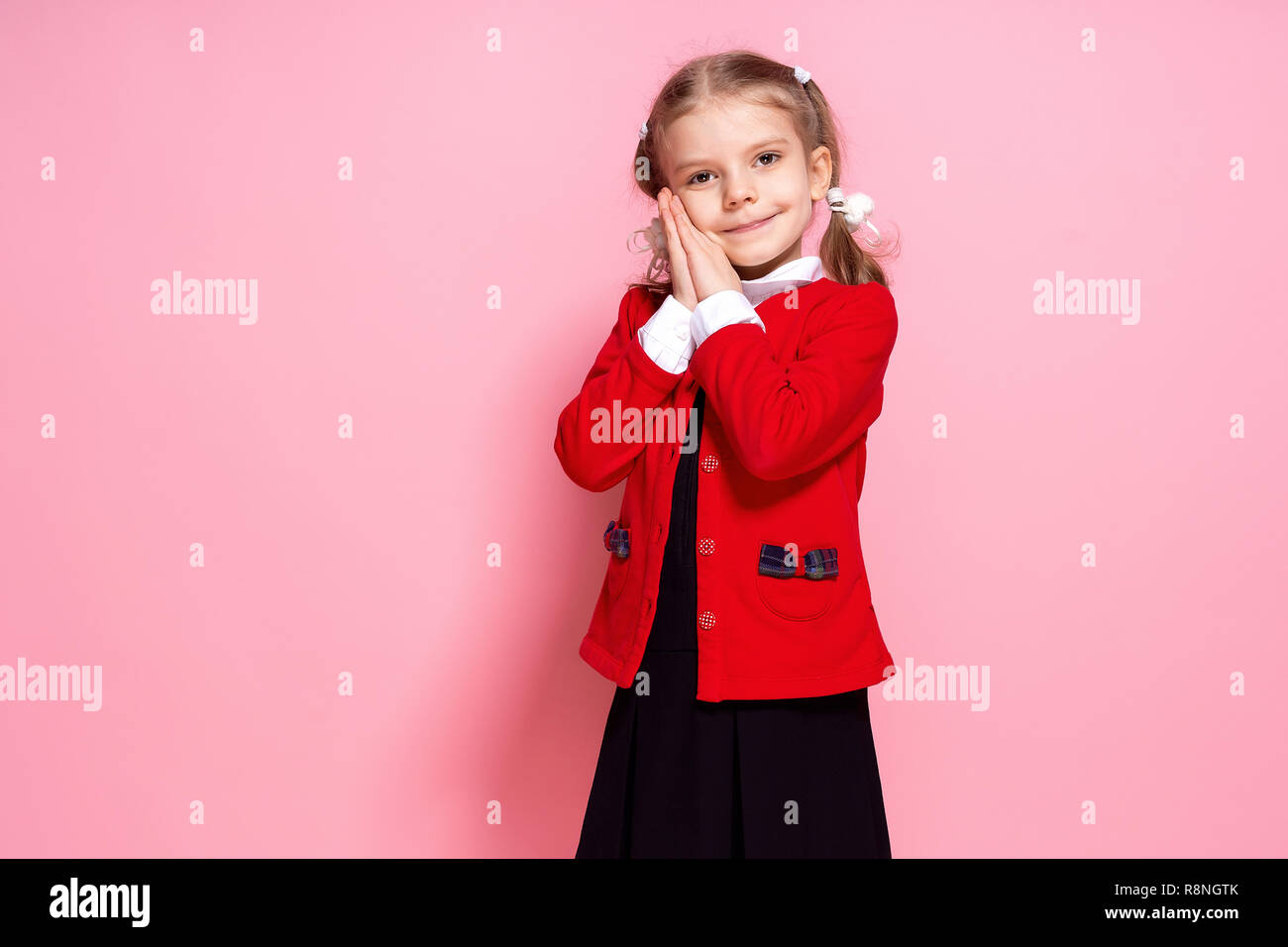 Adorable little girl in red school jacket and black dress looking at ...