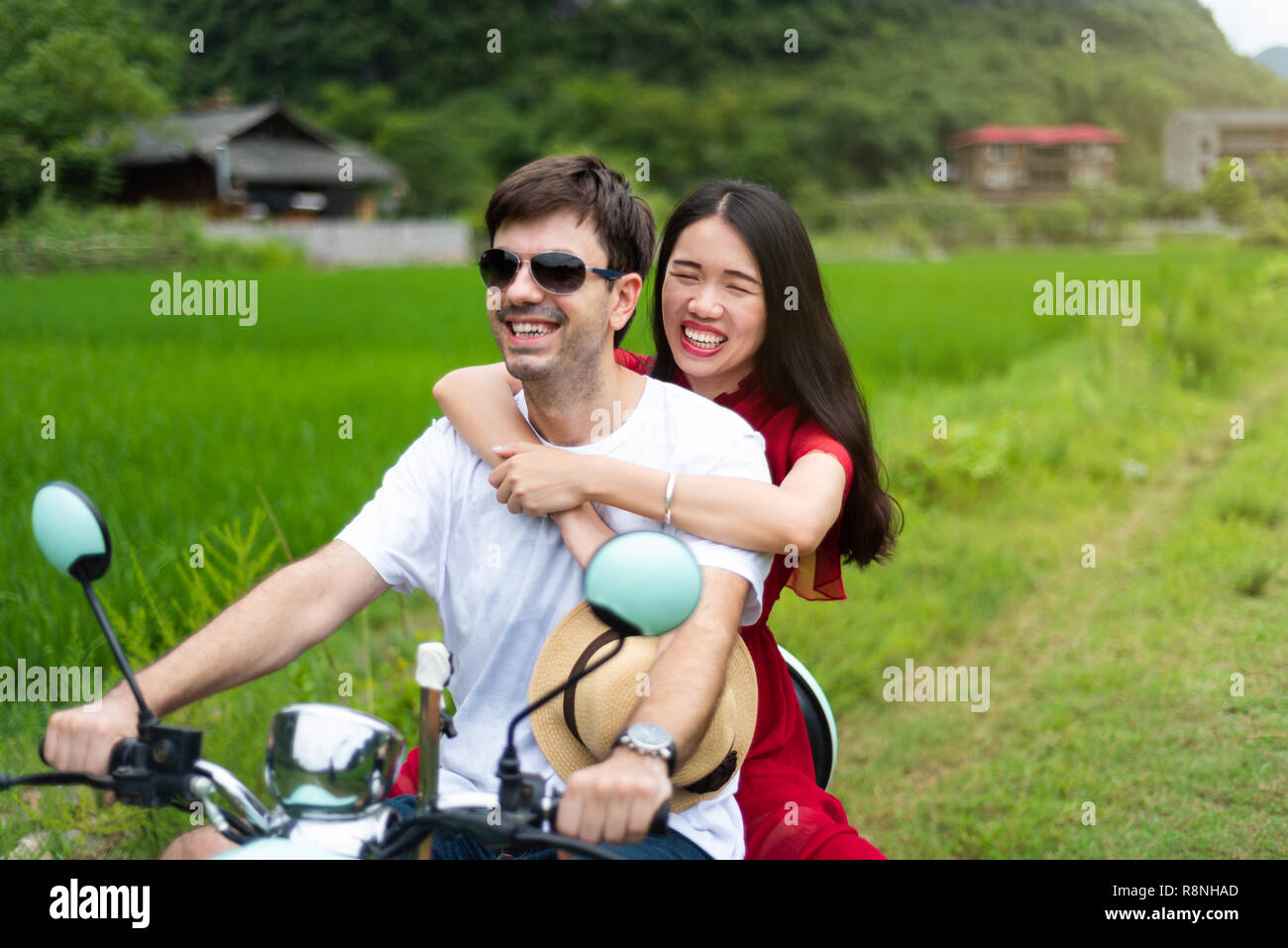 Couple having fun on motorbike around rice fields of Yangshuo, China ...
