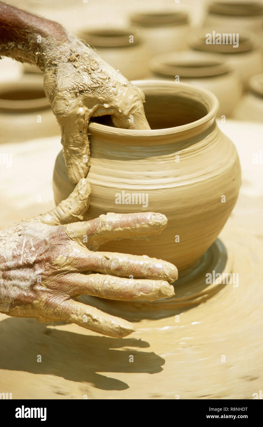 Pottery, traditional Indian kumhar, potter hands giving shape to clay ...