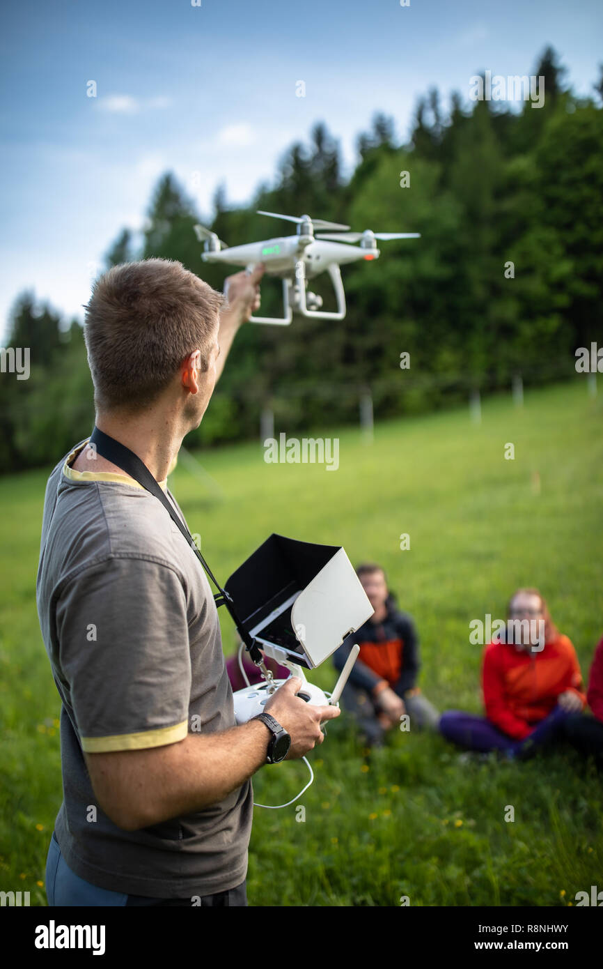 Man Operating a Drone by a Remote Control outdoors Stock Photo - Alamy