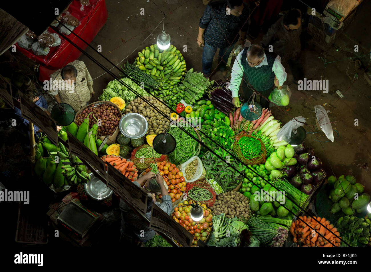 DHAKA, BANGLADESH - DECEMBER 15 : Bangladeshi people browsw vegetable ...