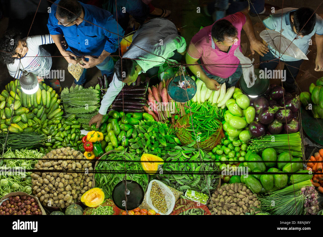 DHAKA, BANGLADESH - DECEMBER 15 : Bangladeshi people browsw vegetable ...