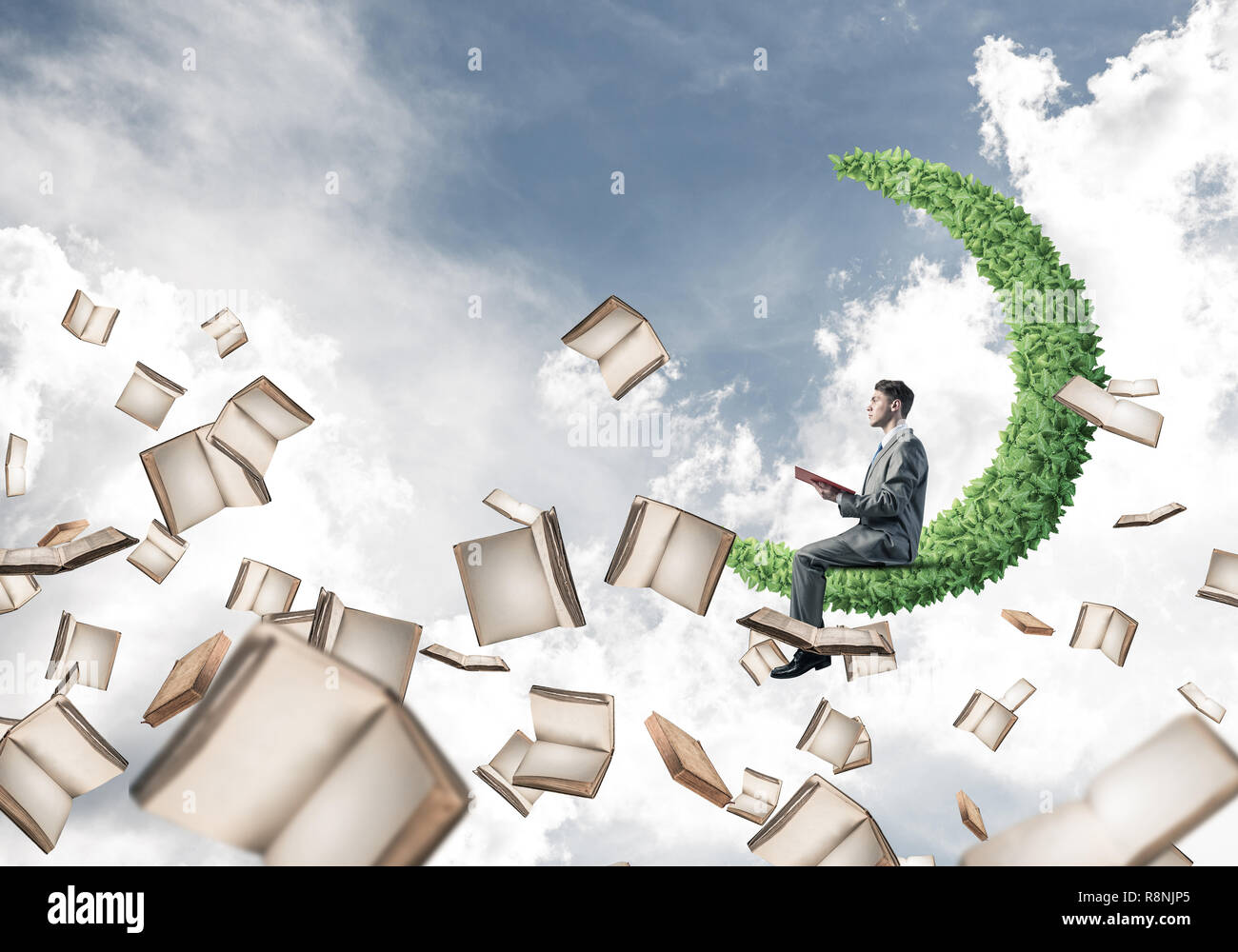 Man reading book and many of them flying in air Stock Photo - Alamy