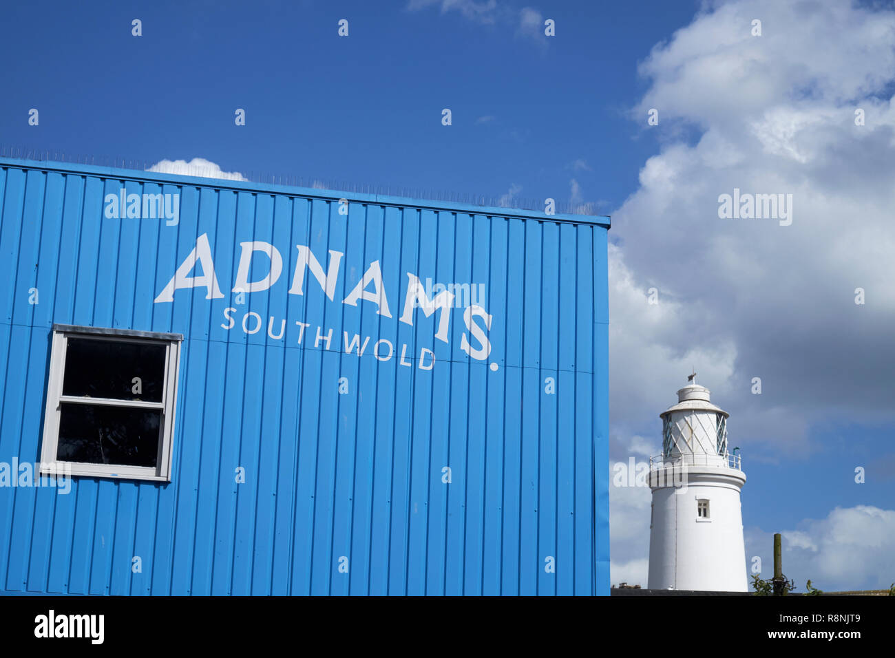 An Adnams brewery building with the lighhouse in the background ...
