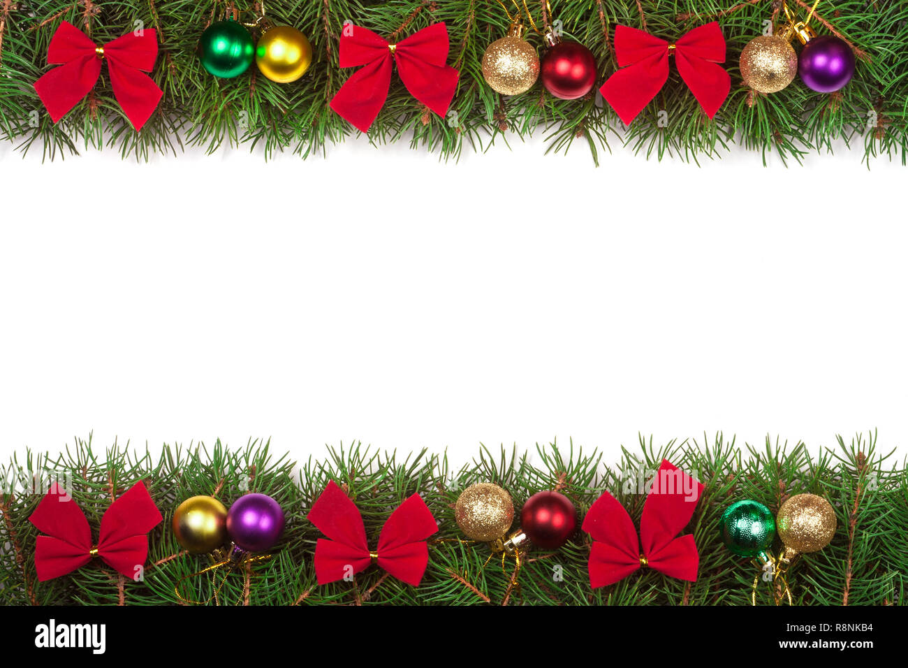 Christmas frame made of fir branches decorated with balls and red bows ...