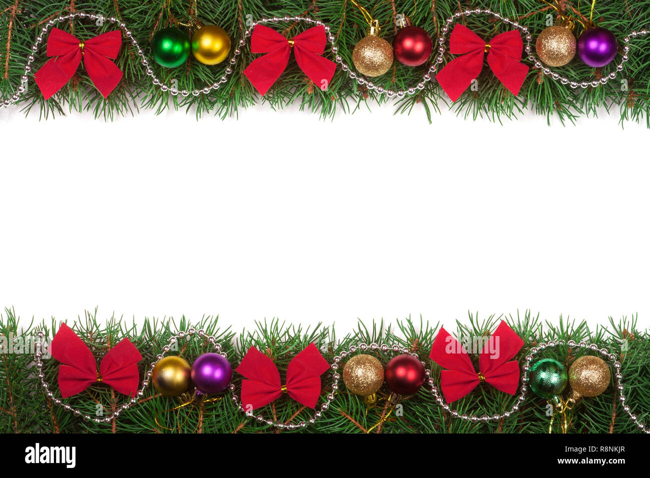 Christmas frame made of fir branches decorated with balls beads and red ...