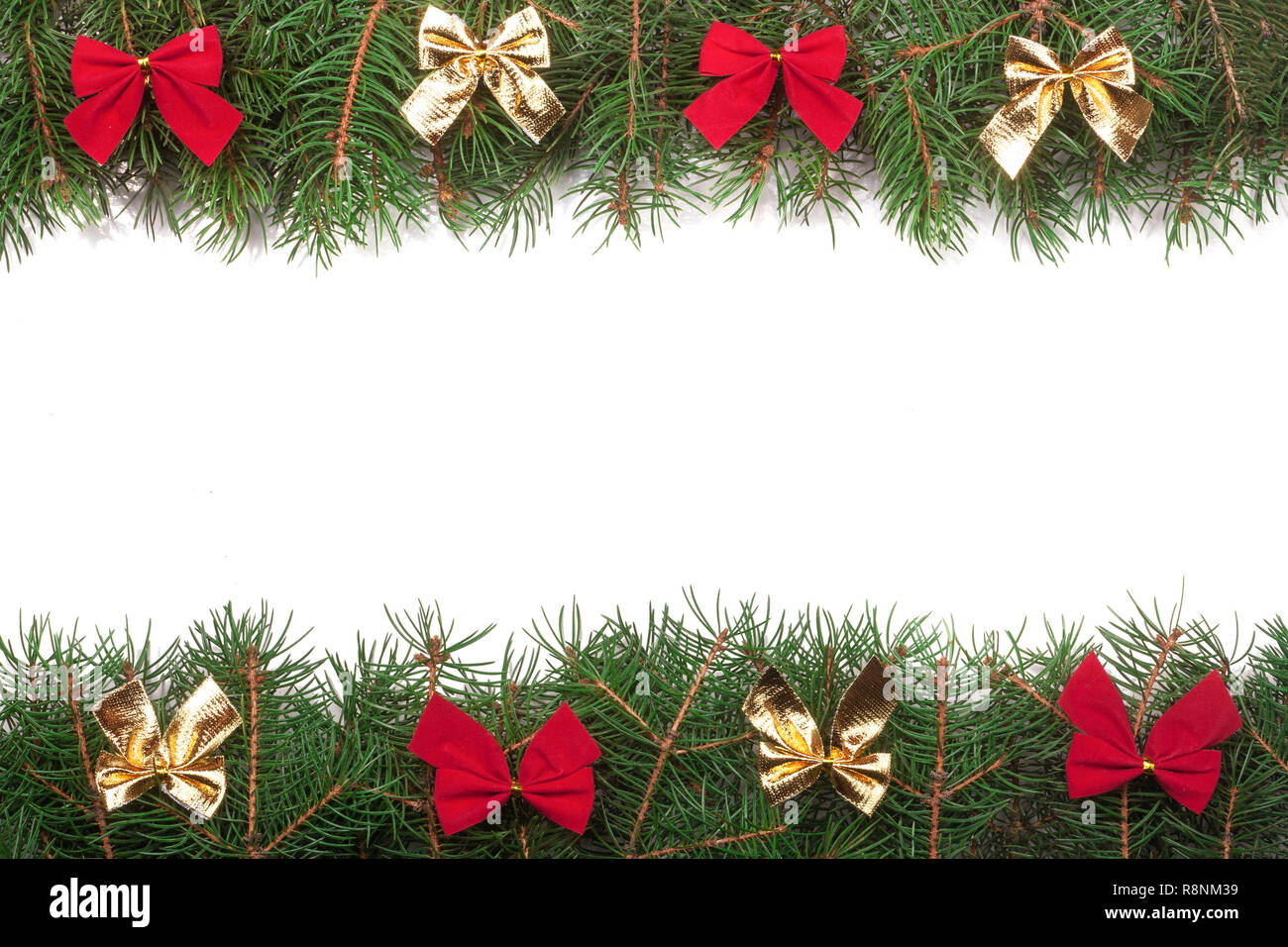 Christmas frame made of fir branches decorated with bows isolated on ...