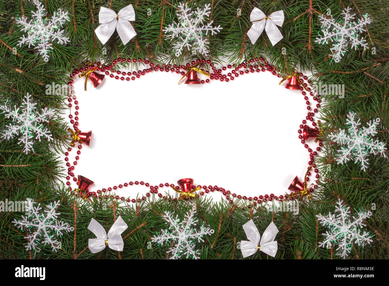 Christmas frame made of fir branches decorated with bows bells and ...