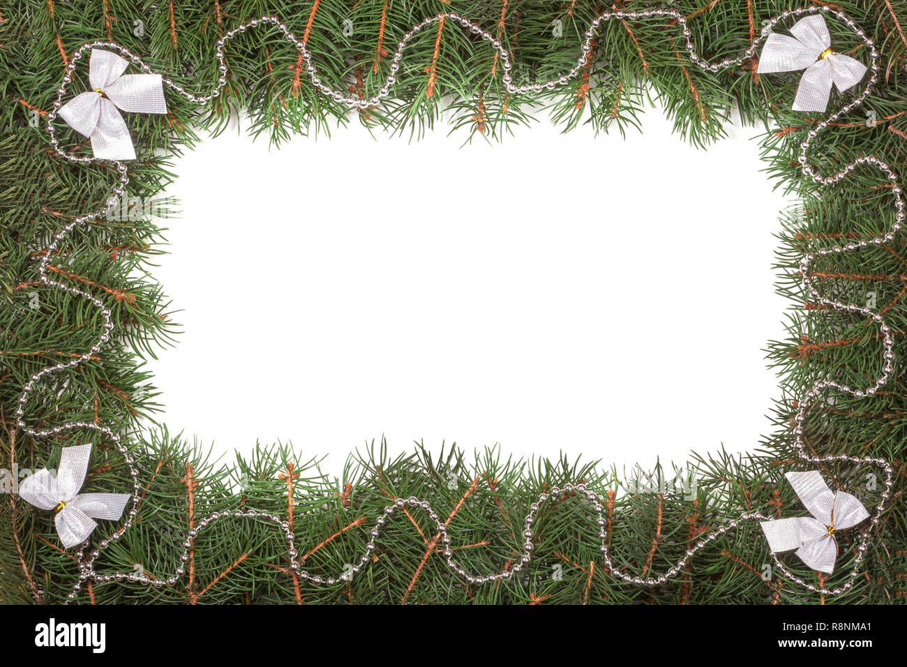 Christmas frame made of fir branches decorated with beads and bows ...