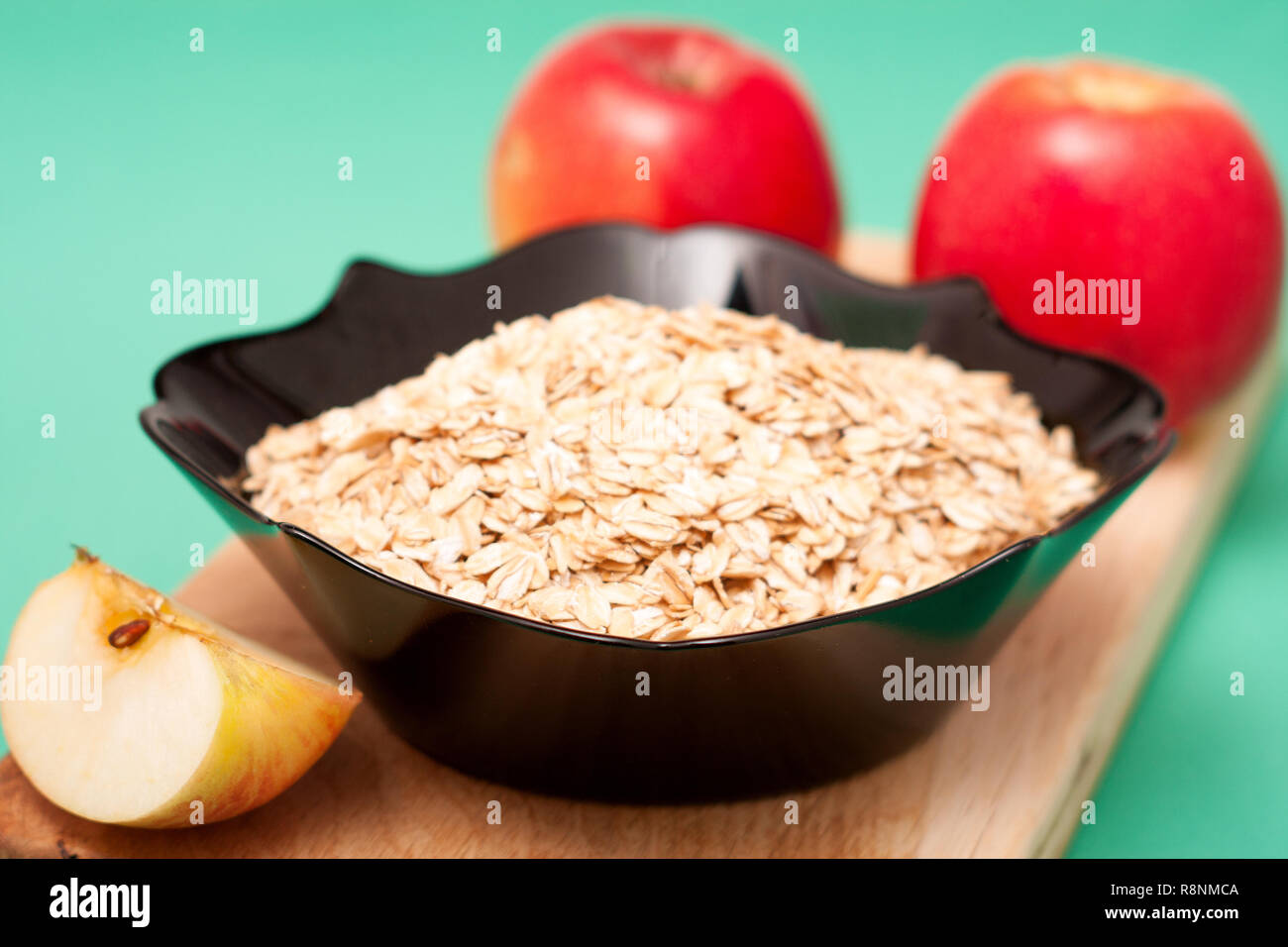 apple with oat flakes in bowl Stock Photo - Alamy