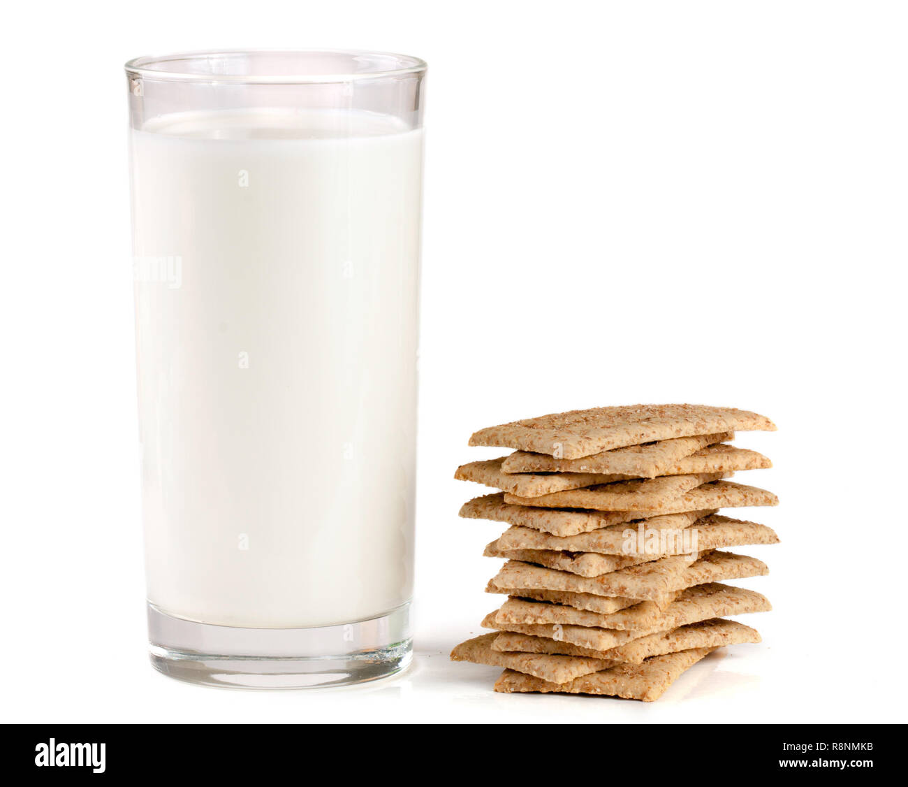glass of milk with stack of grain crispbreads isolated on white ...