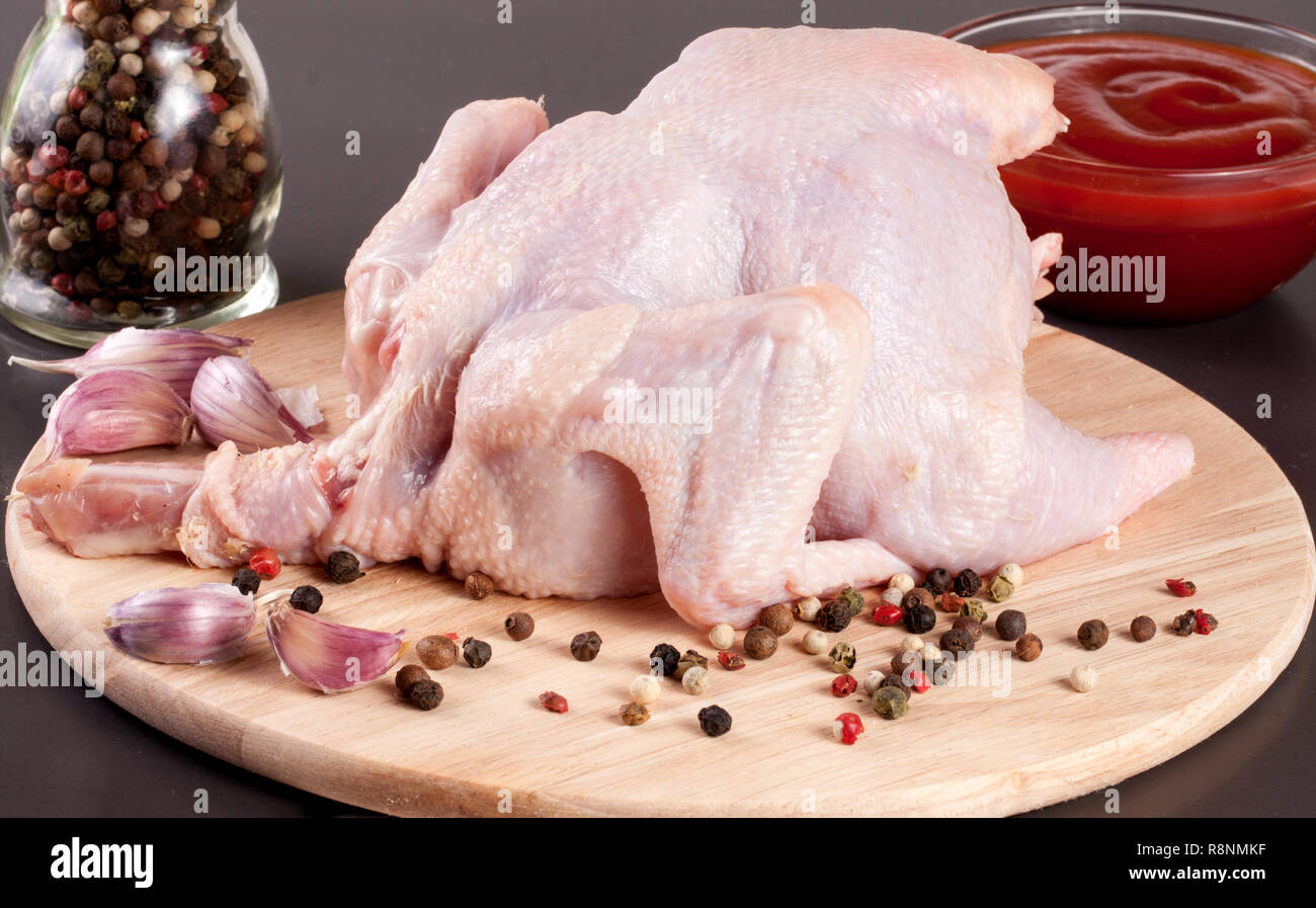 raw chicken carcass with peppercorns on a dark background Stock Photo ...