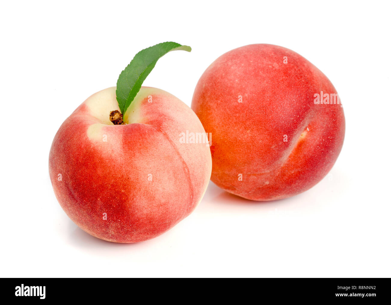 Two peaches with green leaf isolated on white background Stock Photo ...