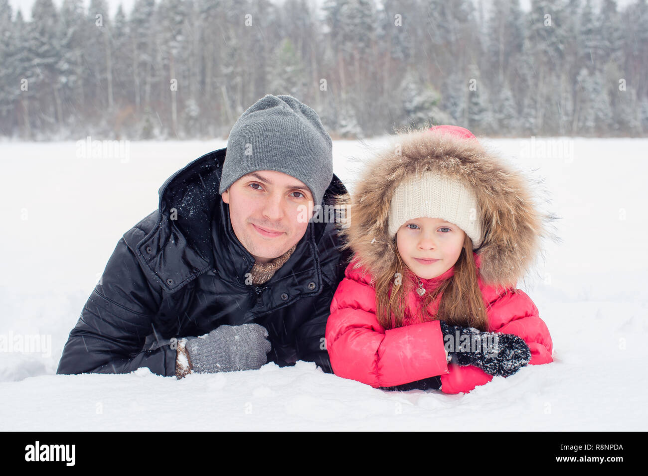Happy family of dad and kid enjoy winter snowy day Stock Photo - Alamy
