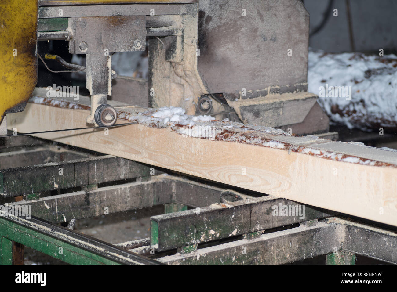 Cutting logs on the boards. In the winter process a tree.Wood ...