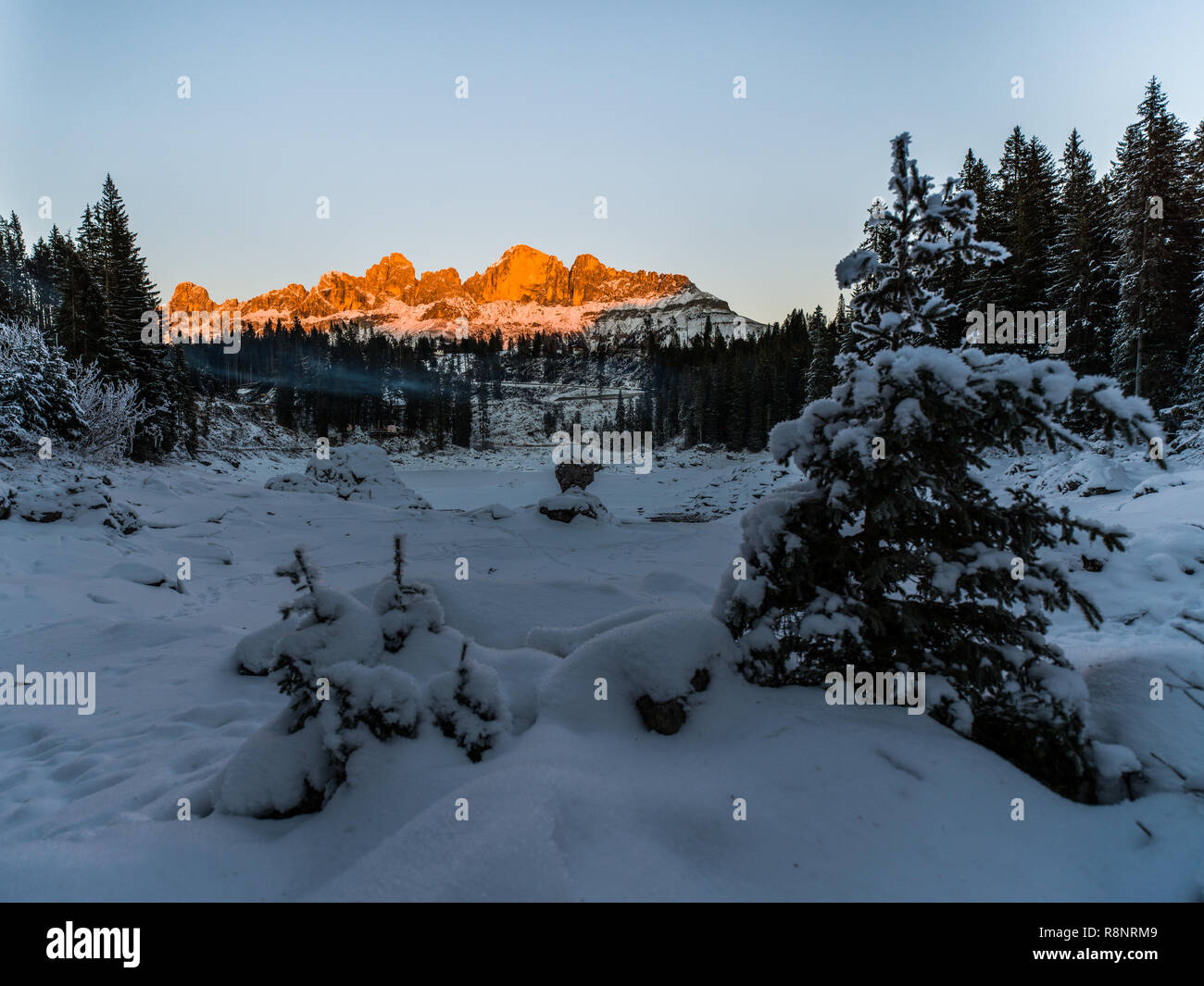 Beautiful alpine glow above frozen lake - Dolomites, Italy at sunset ...