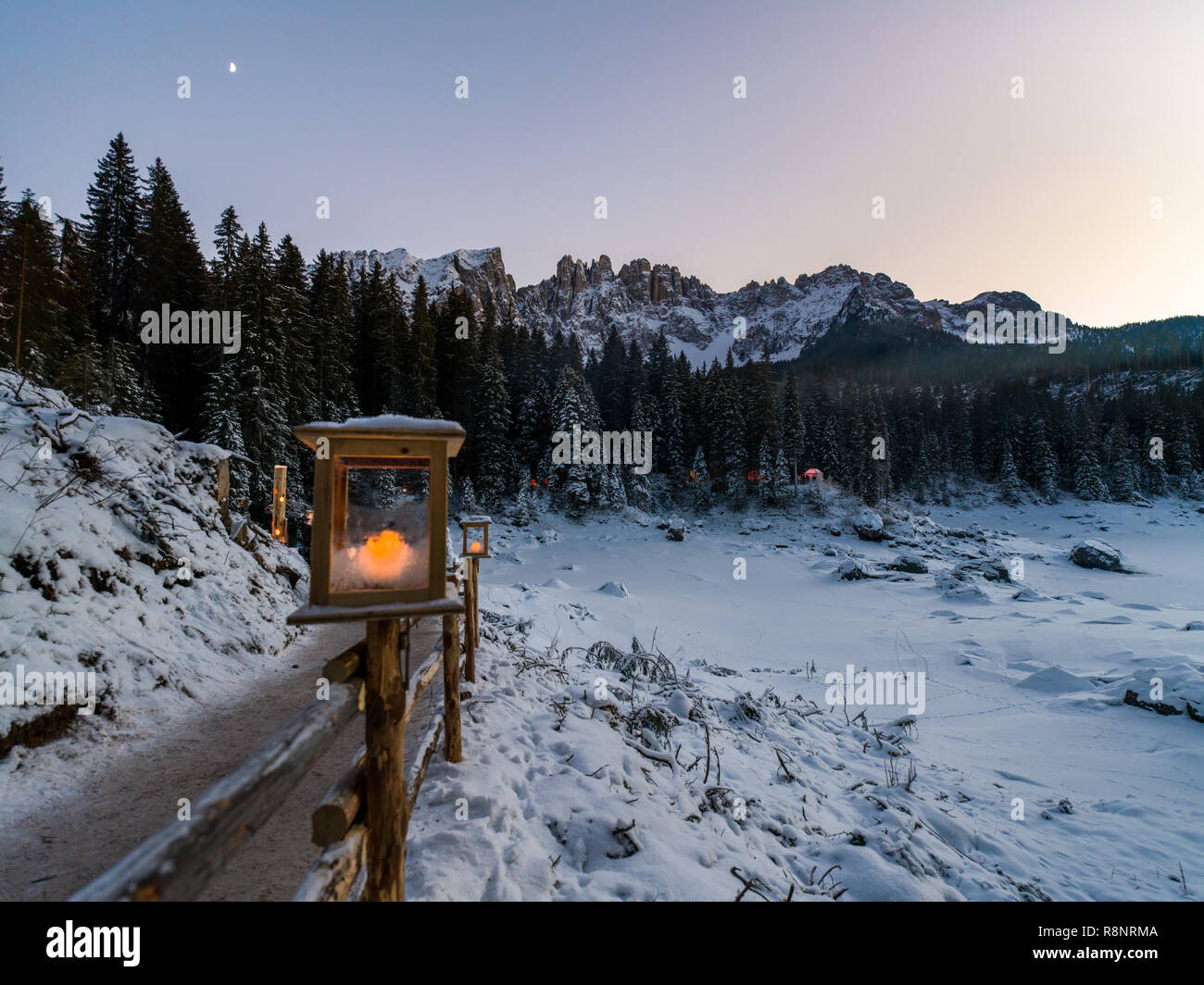 Romantic scene with candle lit path under moonlight towards tent ...
