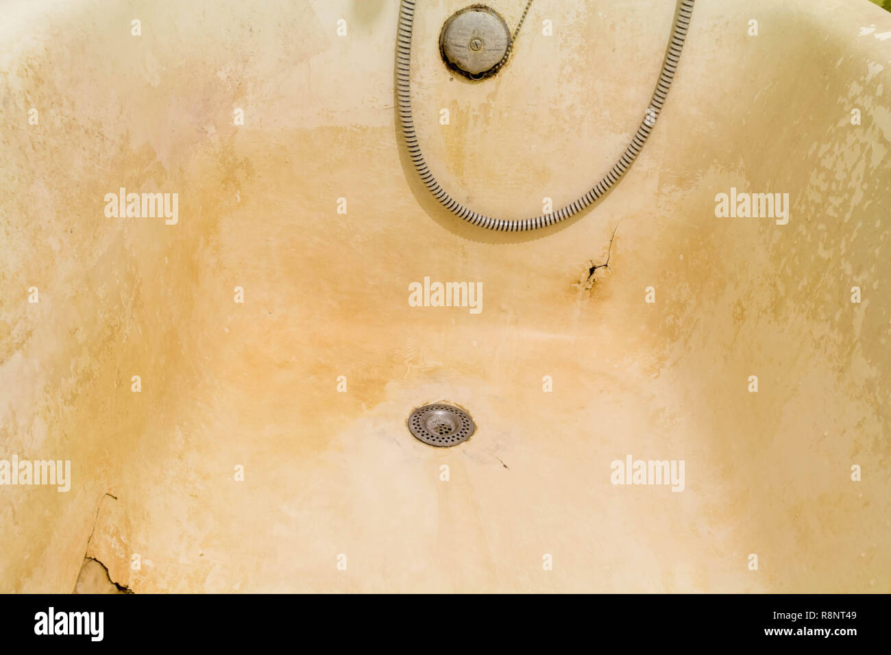 Rusty bath with peeling enamel. Repair is required Stock Photo - Alamy