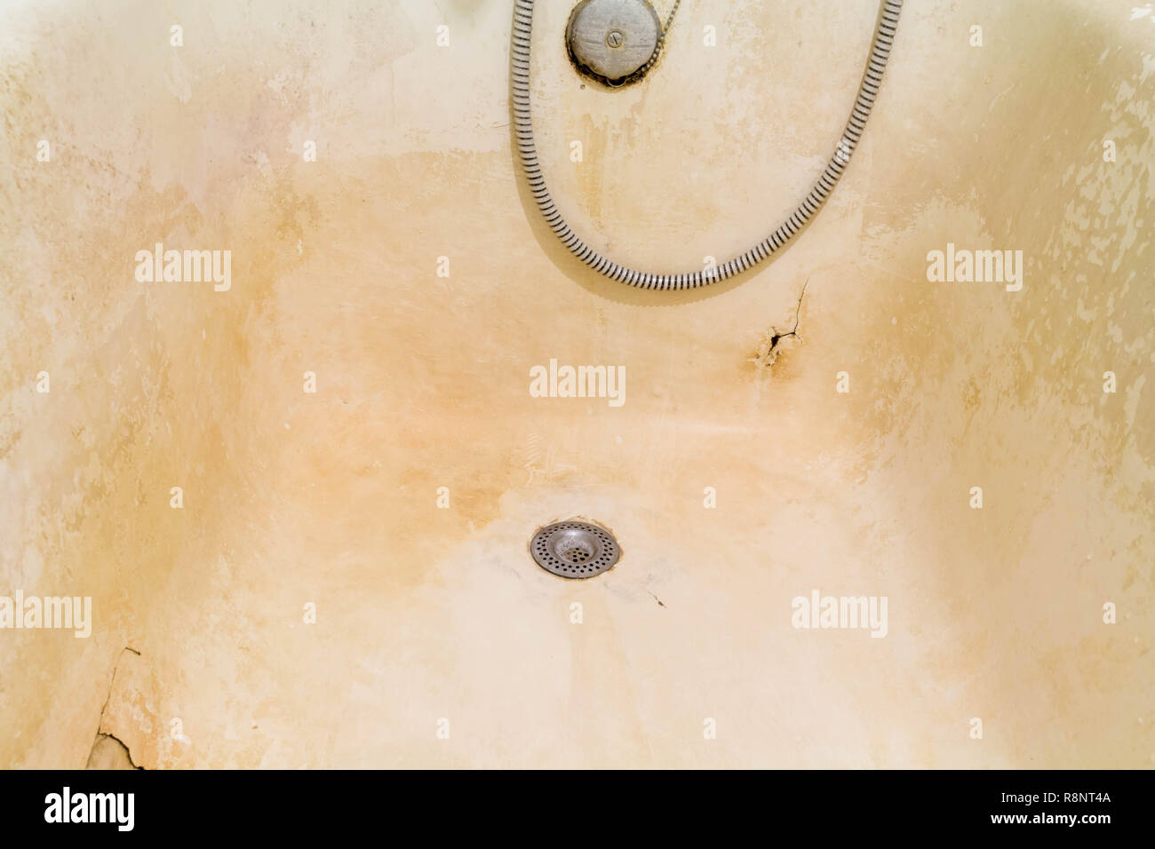Rusty bath with peeling enamel. Repair is required Stock Photo - Alamy