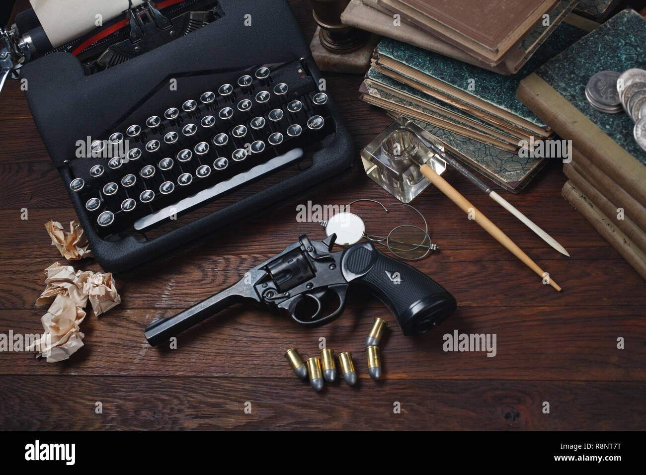 Writing a detective story - old retro vintage typewriter and revolver ...
