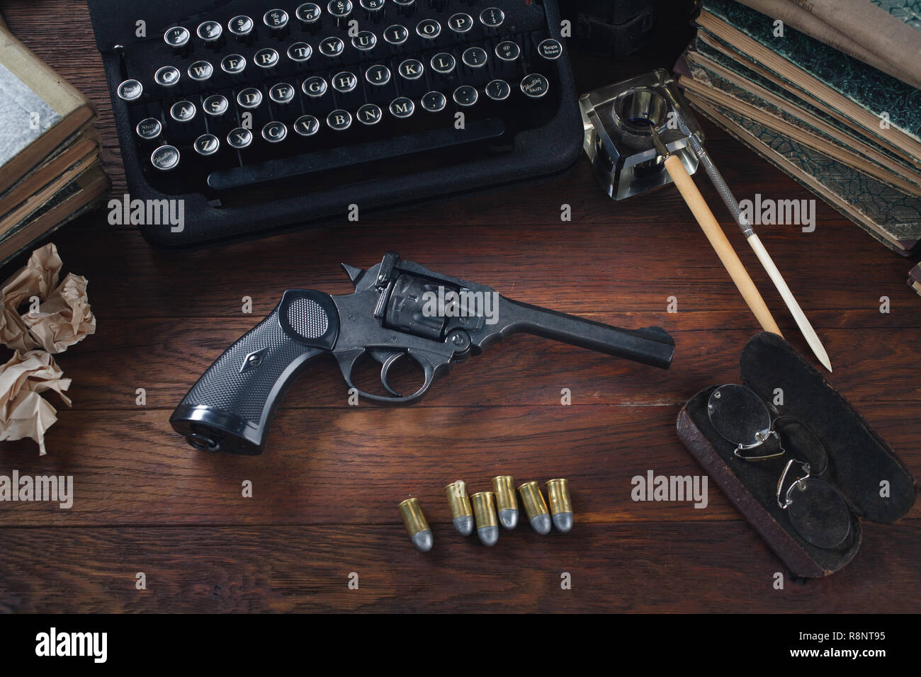Writing a detective story - old retro vintage typewriter and revolver ...