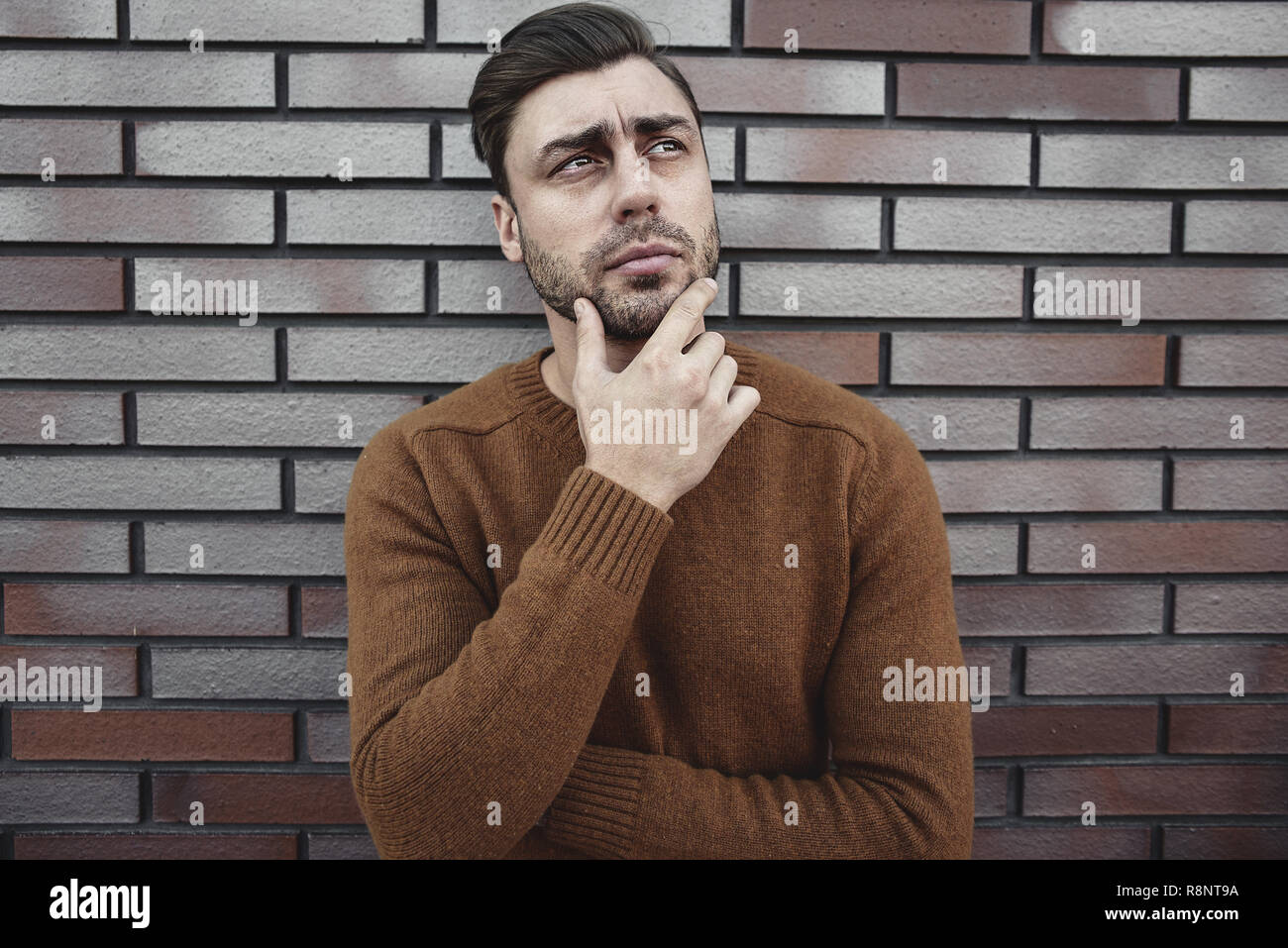 Portrait of handsome serious man thinking about something isolated on ...