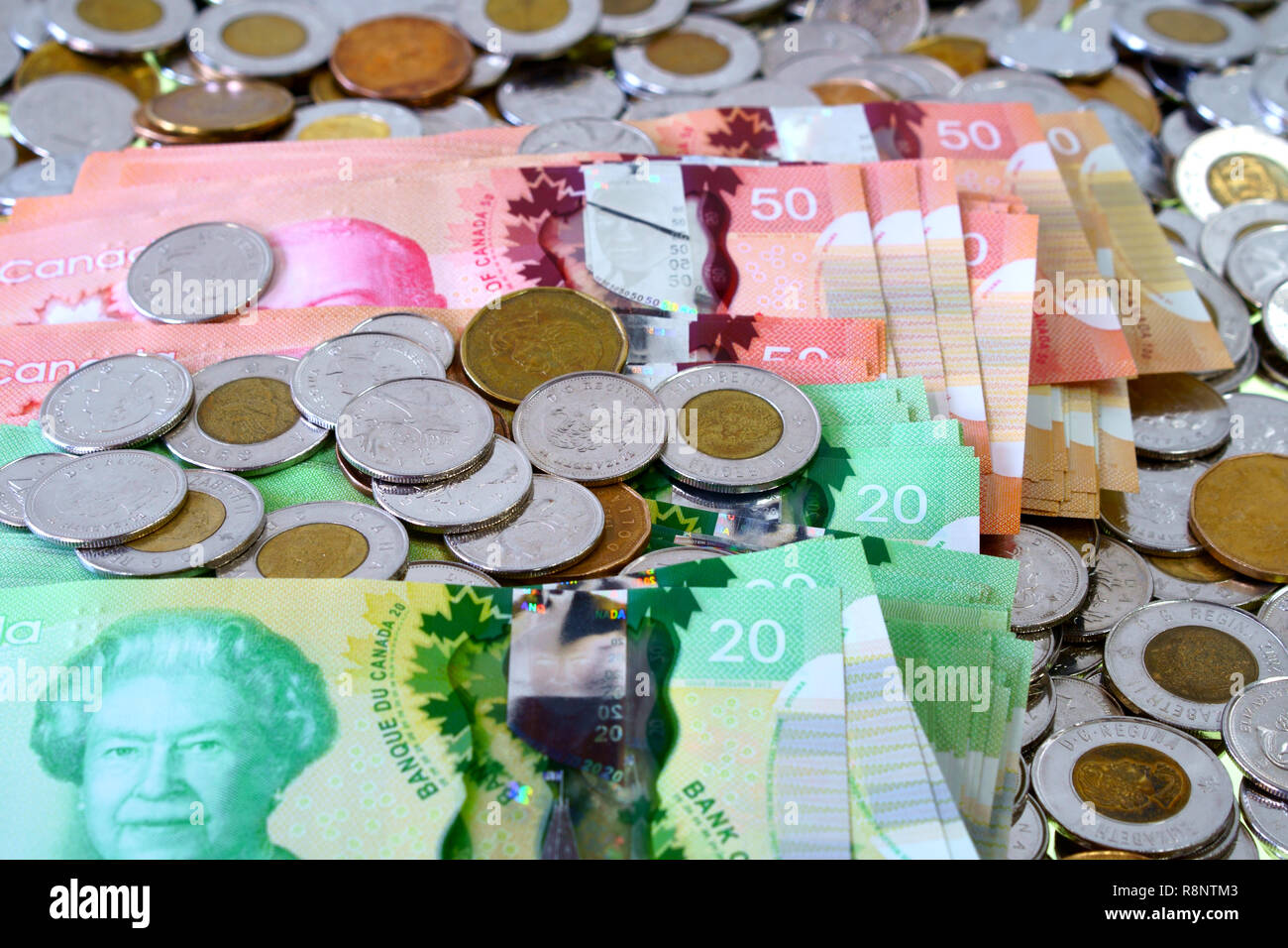 Many canadian dollar bills and spare change spread and filling the ...