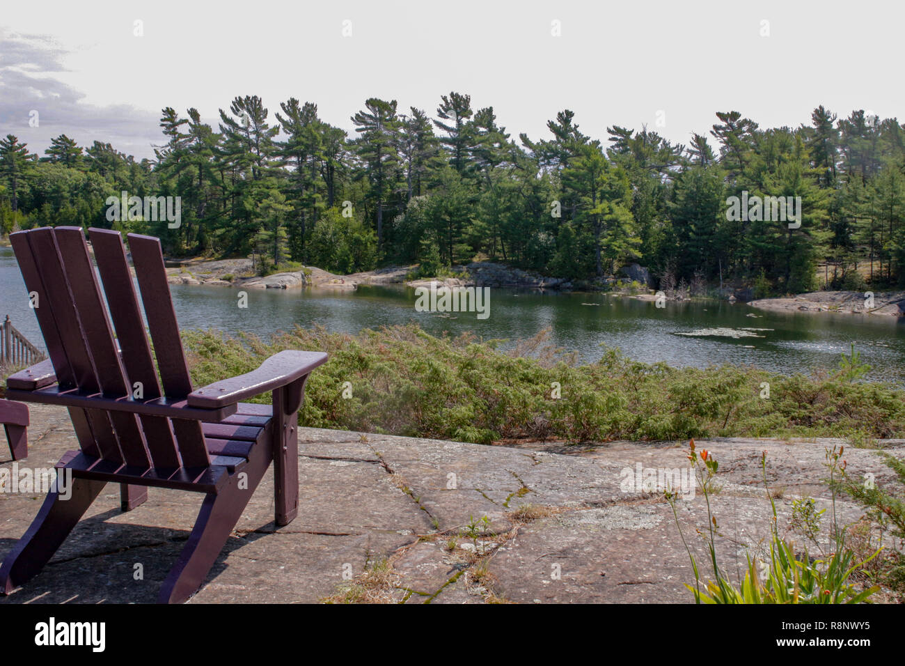 Dock and muskoka chairs on lake muskoka hi-res stock photography and ...