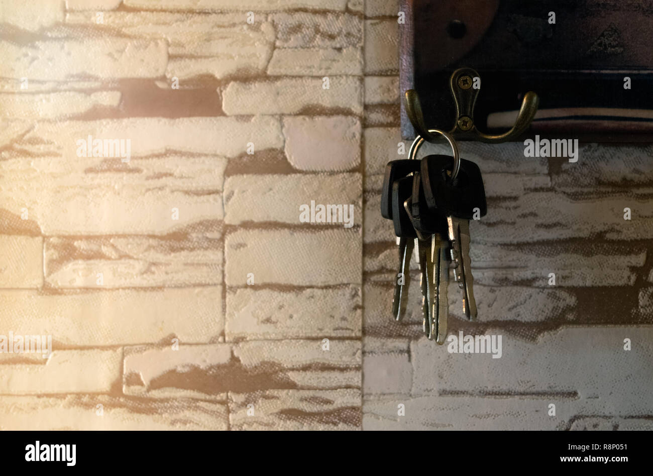 A few keys hanging on the wall with copy space for text Stock Photo - Alamy