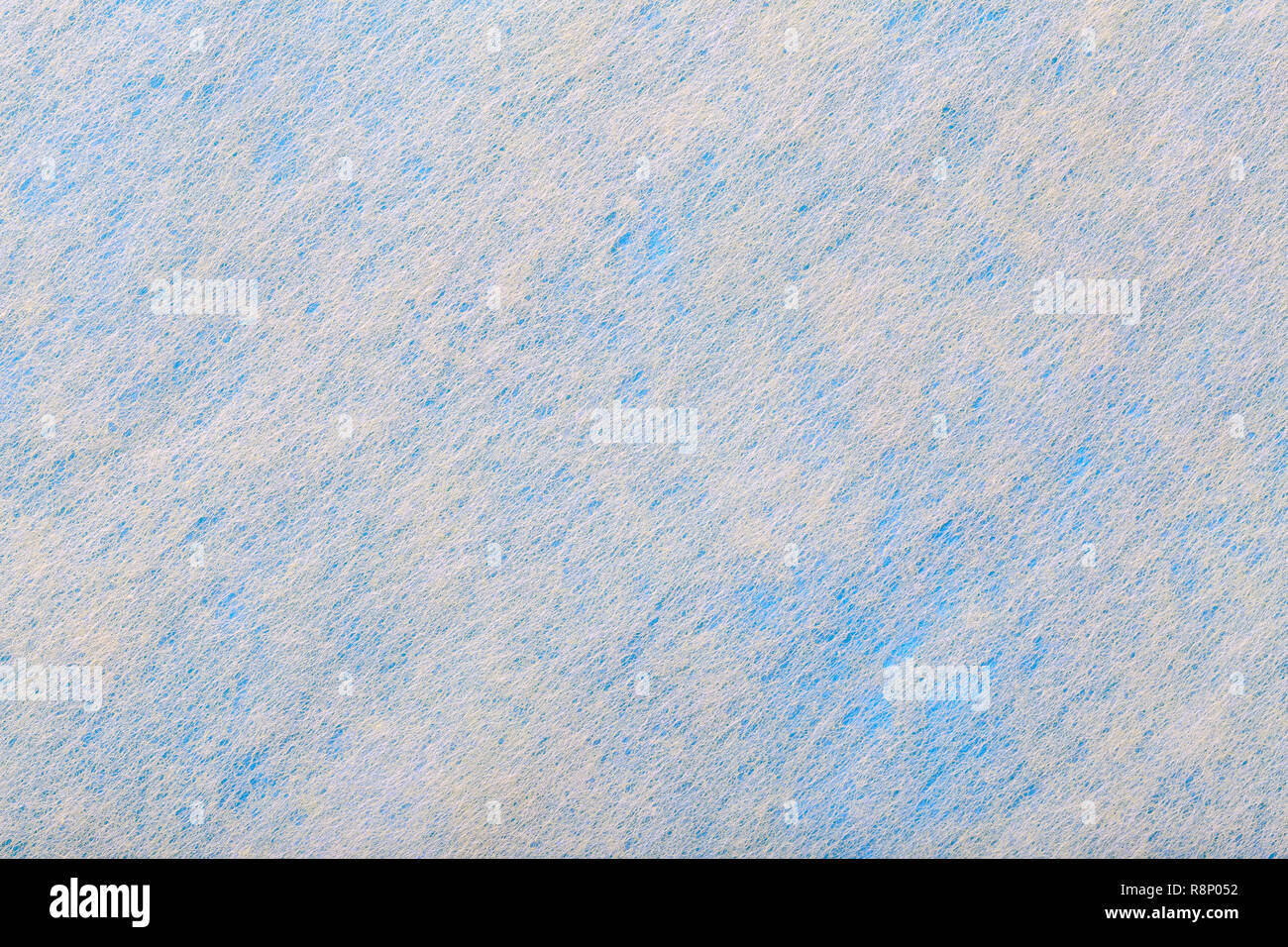 Structure of white background with blue spots of felt fabric, closeup ...