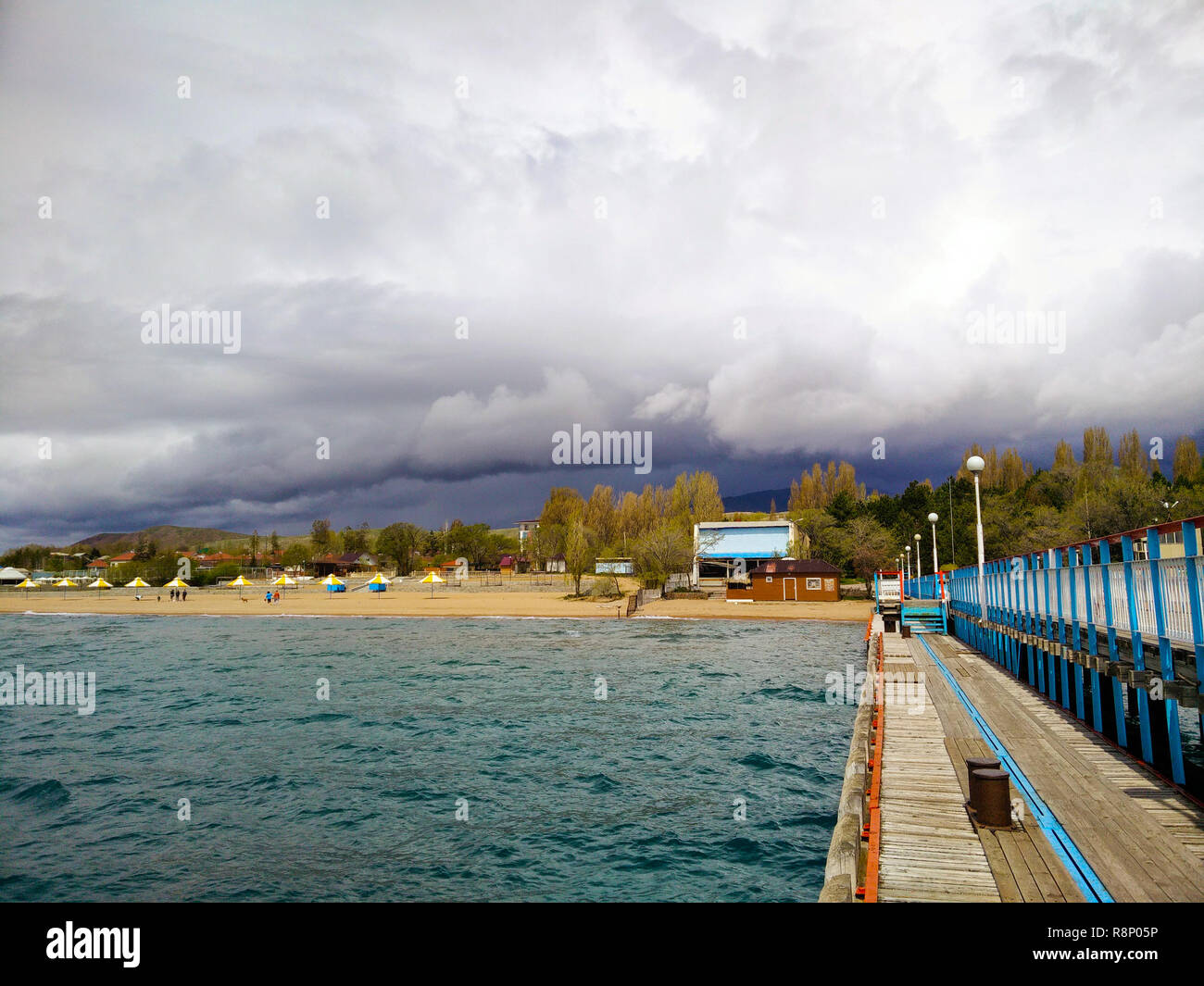 Beach. Bad weather. High mountains on the beach background. View of ...