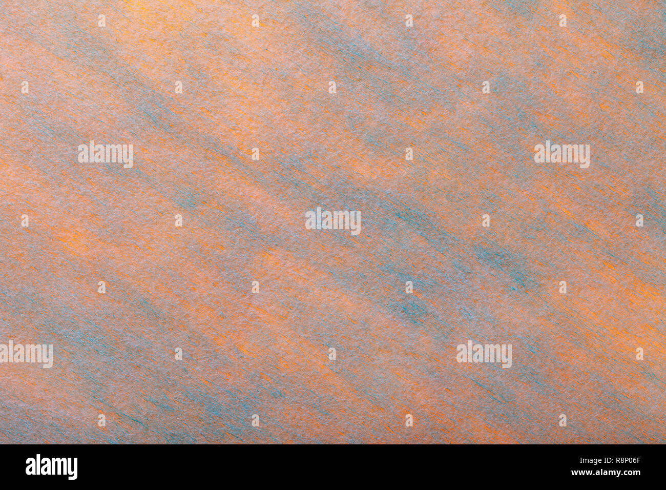Structure of a light coral background with blue spots of felt fabric ...