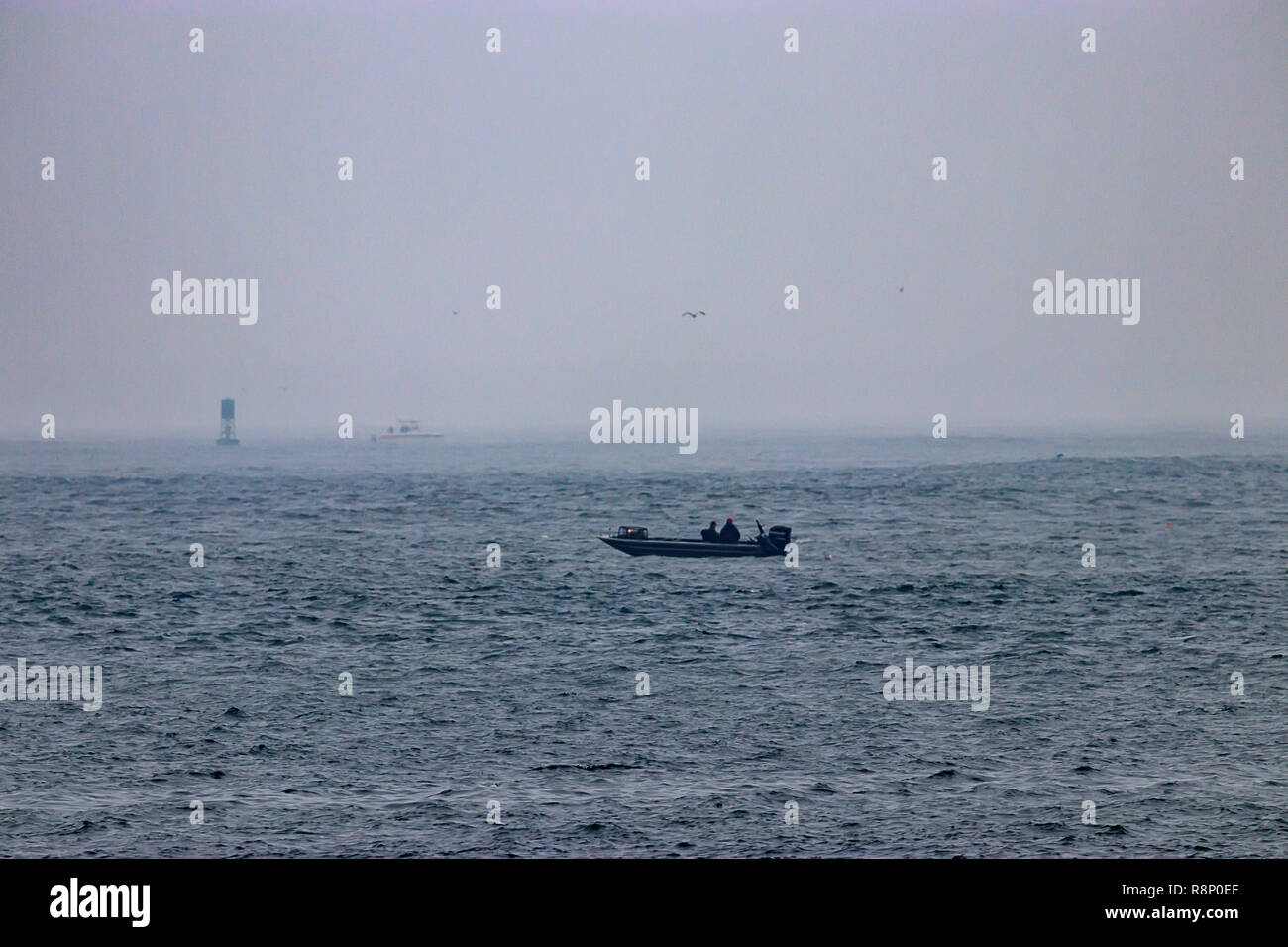 fishing boat in the pacific ocean on choppy gray water Stock Photo - Alamy