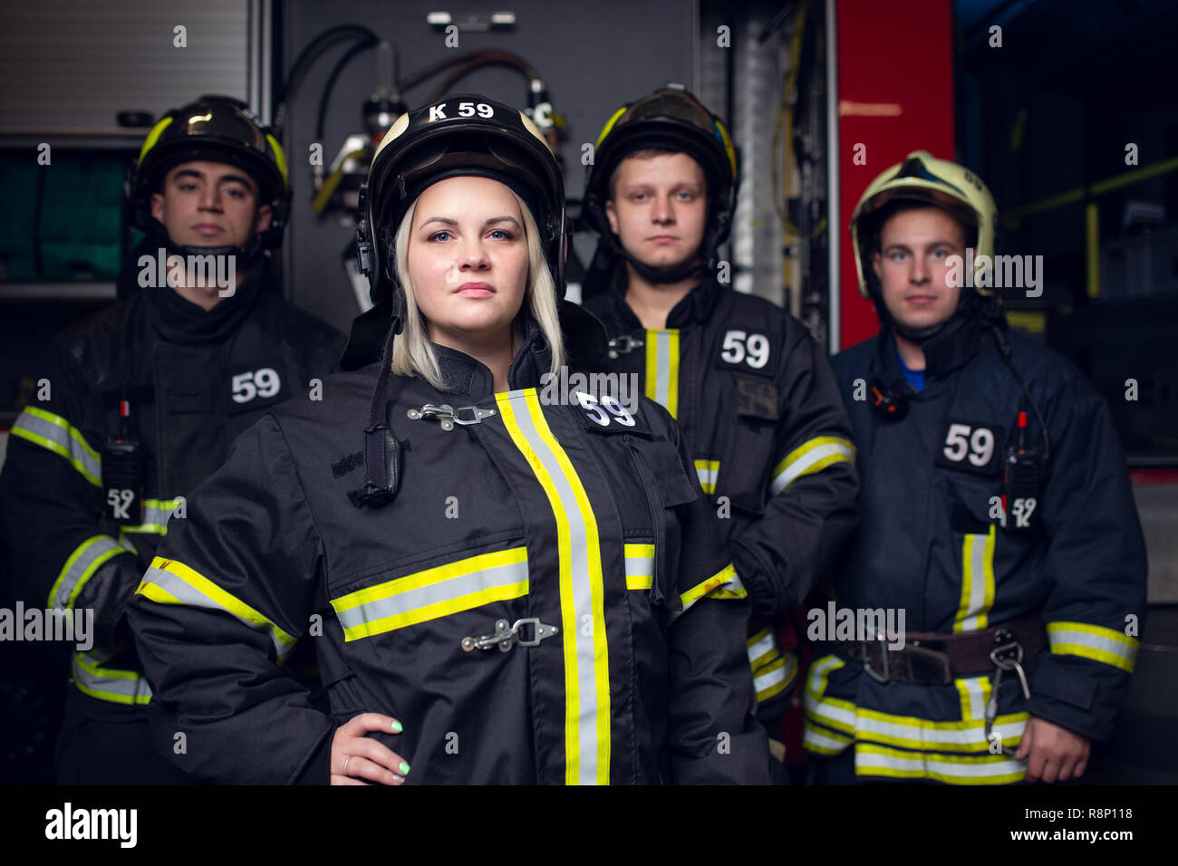 Image of three firemen men and woman on background of fire truck Stock ...