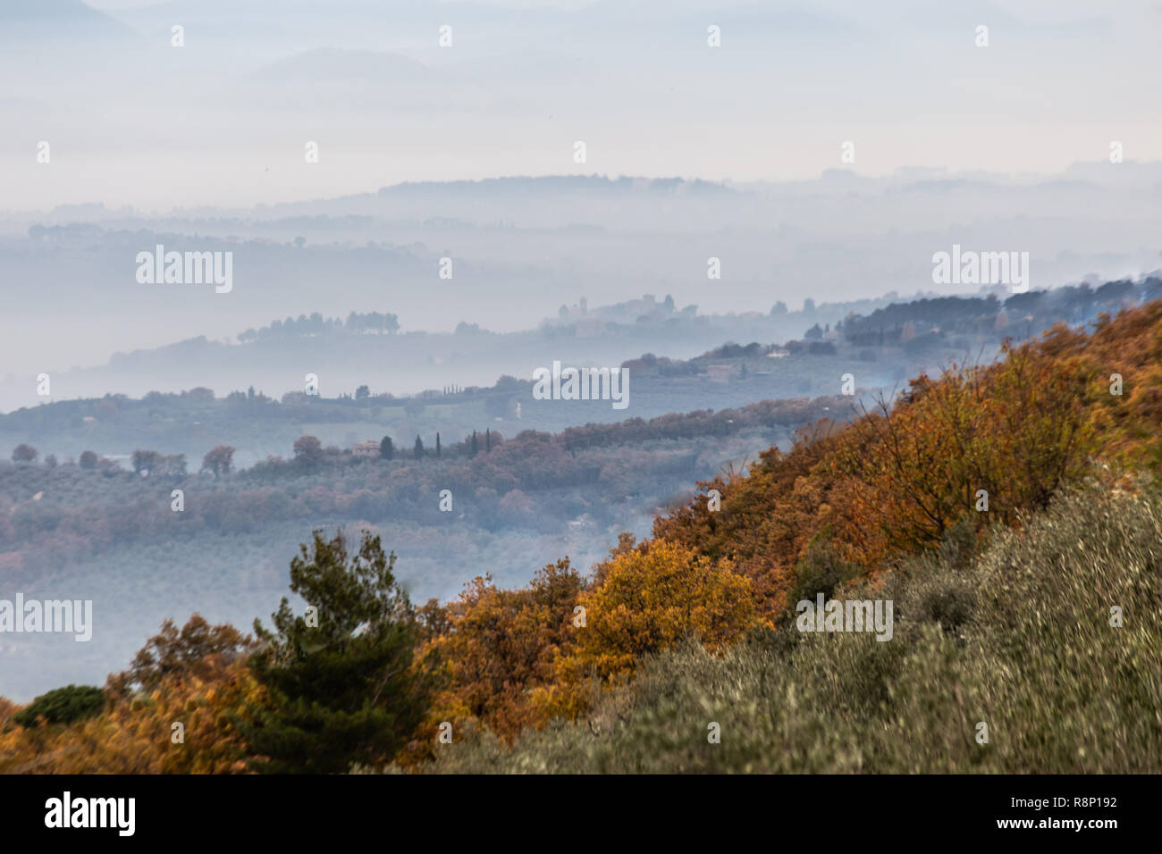 Fog filling a valley in Umbria (Italy), with layers of mountains and ...