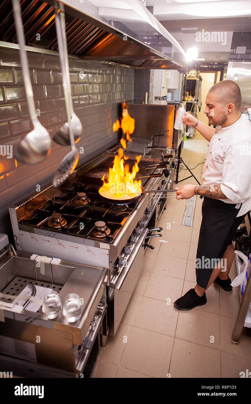 Chef cooking on stove hi-res stock photography and images - Alamy