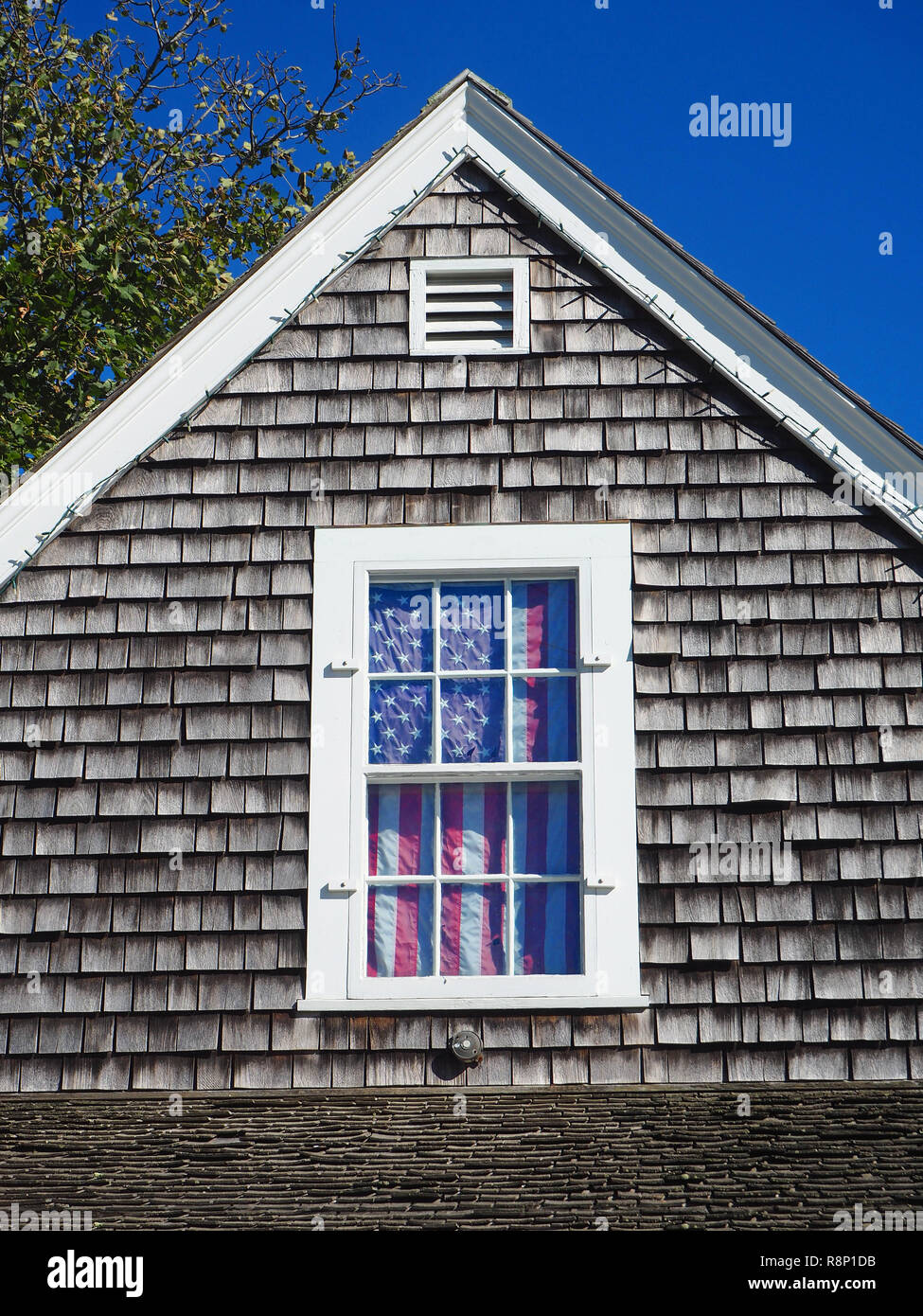 American flag hanging in window Stock Photo - Alamy