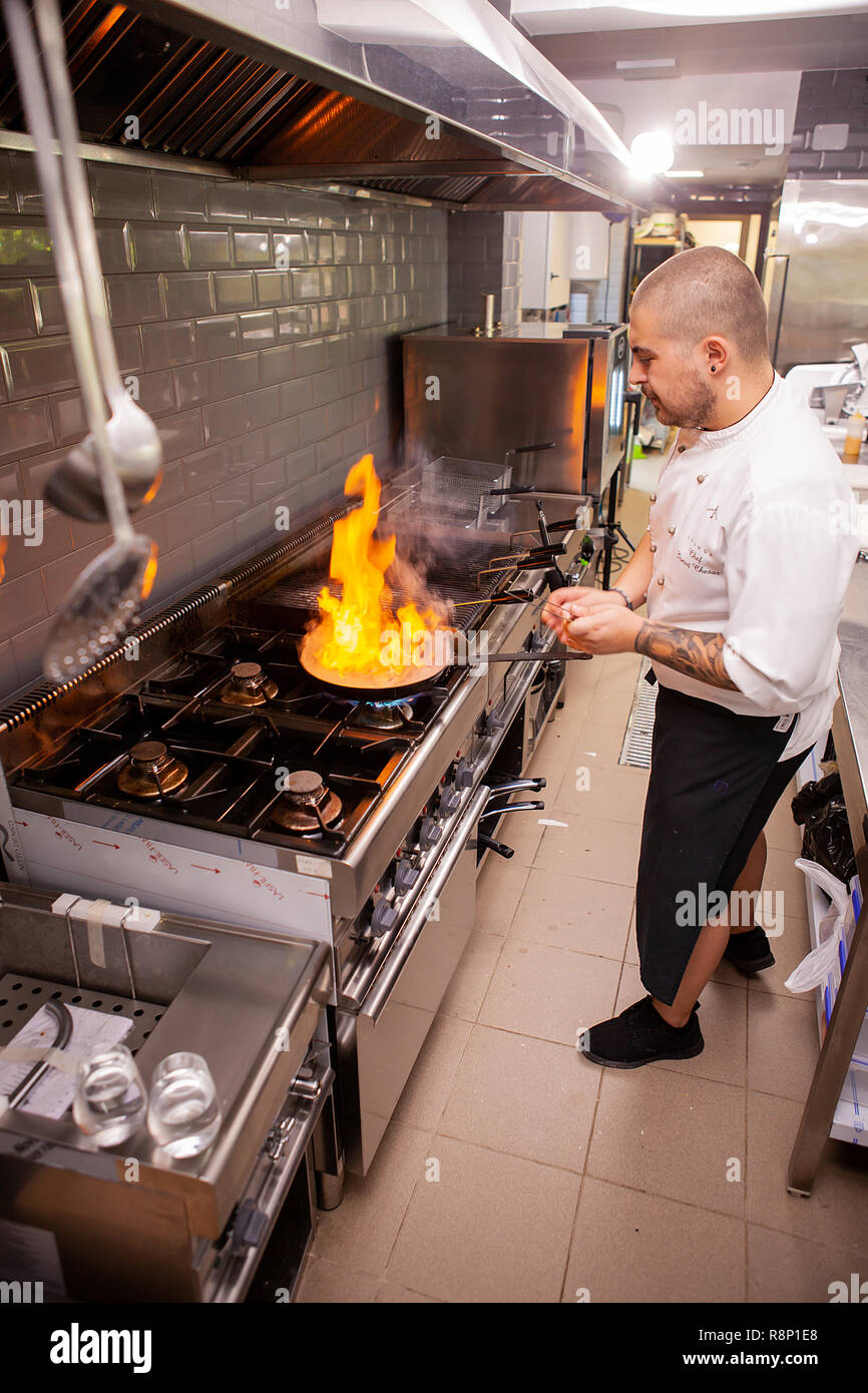 Chef cooking with flame on his restaurant kitchen.Skilled cook Stock ...