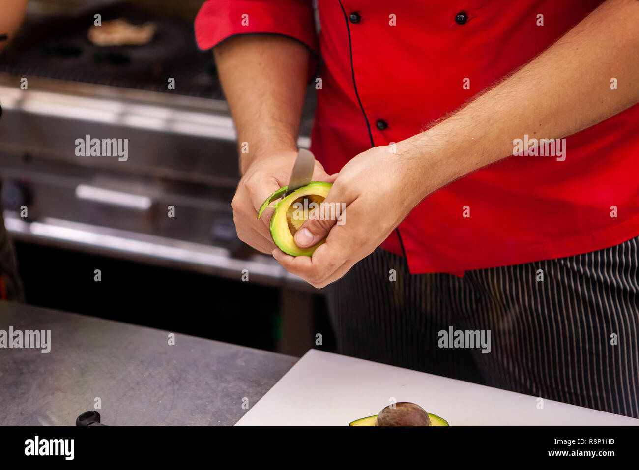 Chef preparing avocado for delicious salade in restaurant kitchen Stock ...