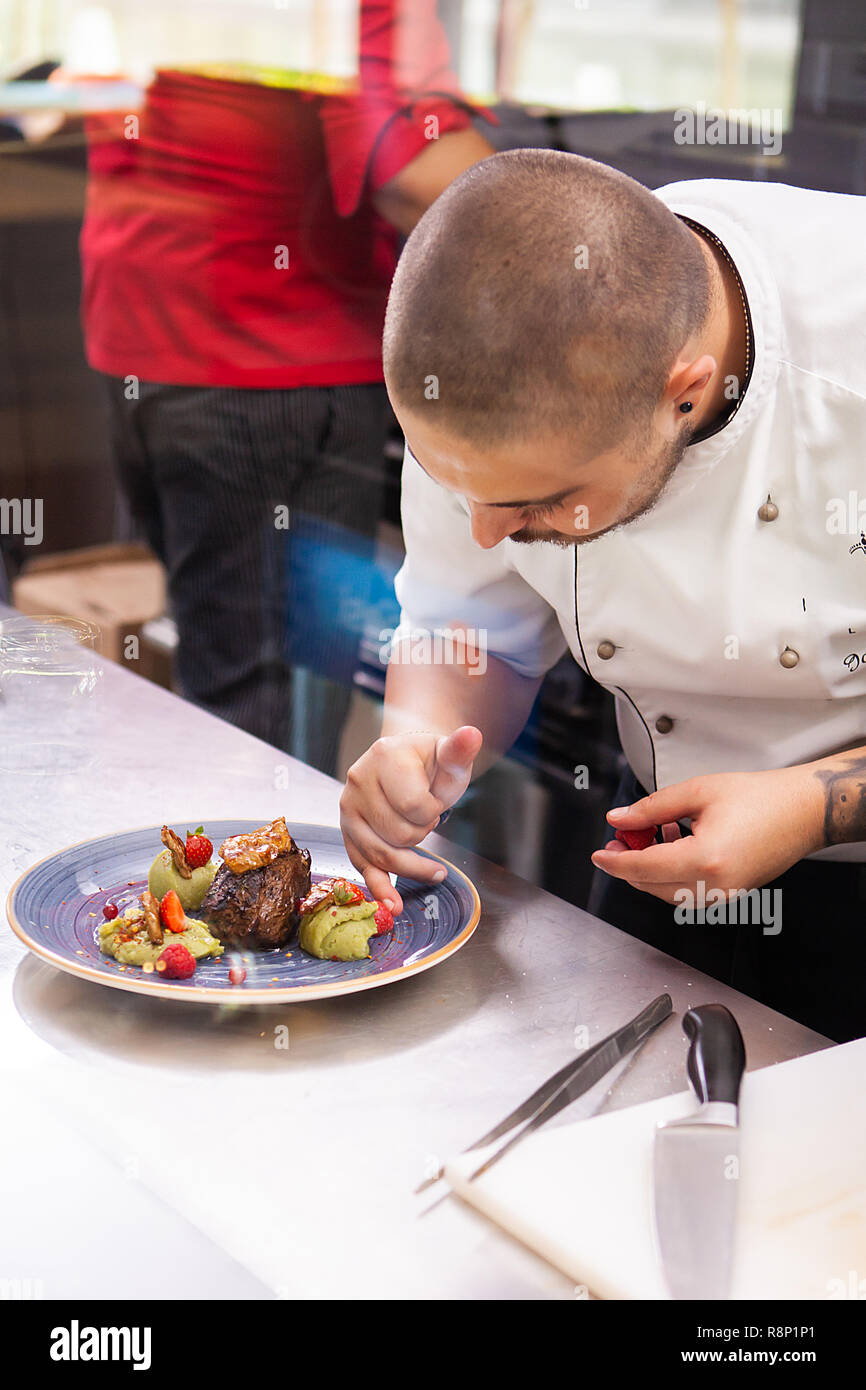 Professional food decoration in restaurant kitchen.Cook doing a great ...