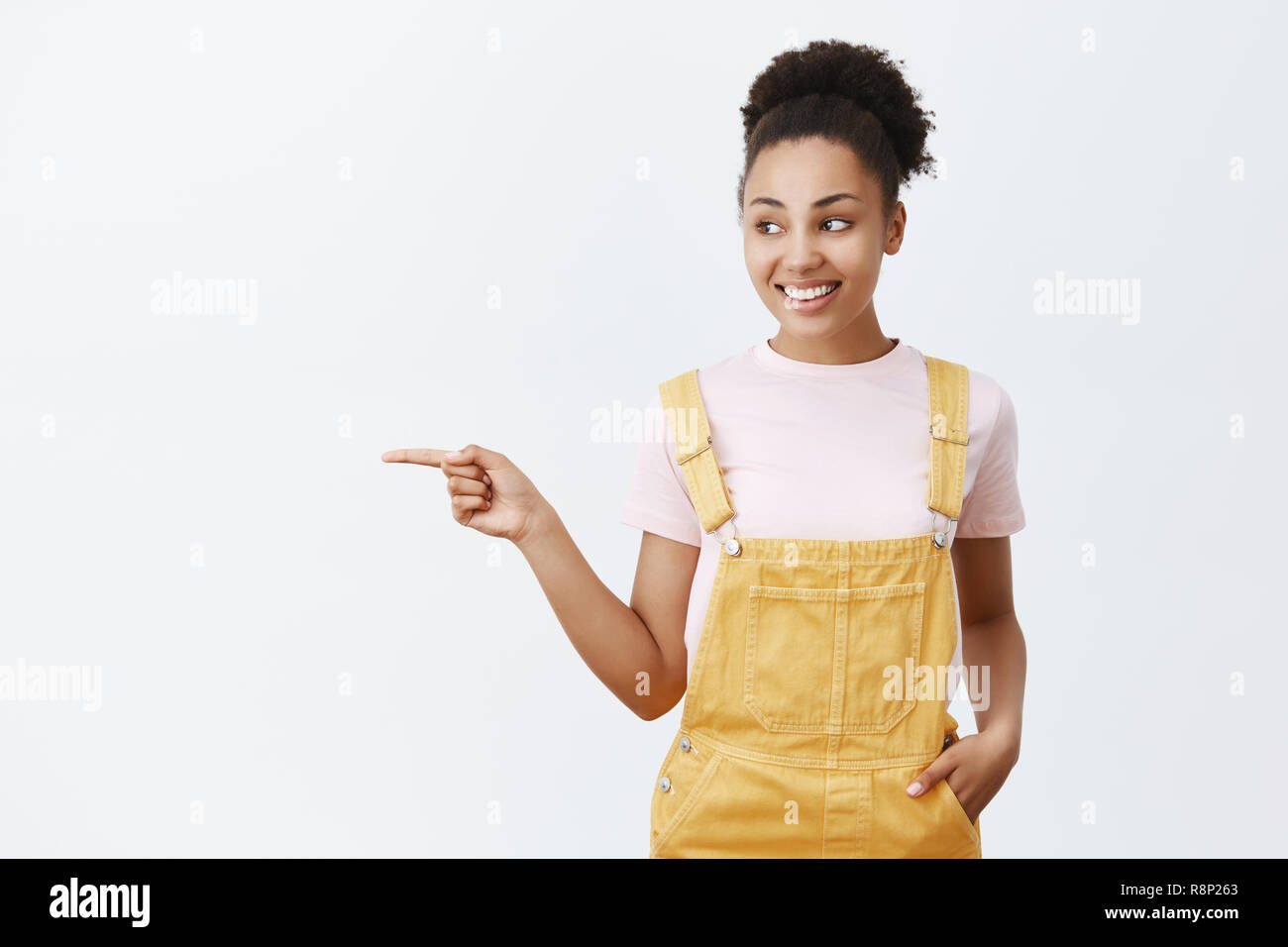 Cute young and tender female sibling with dark skin in yellow trendy ...