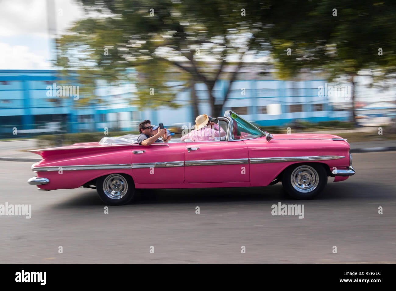 vintage American 1950s car driving at speed with blurred background in ...