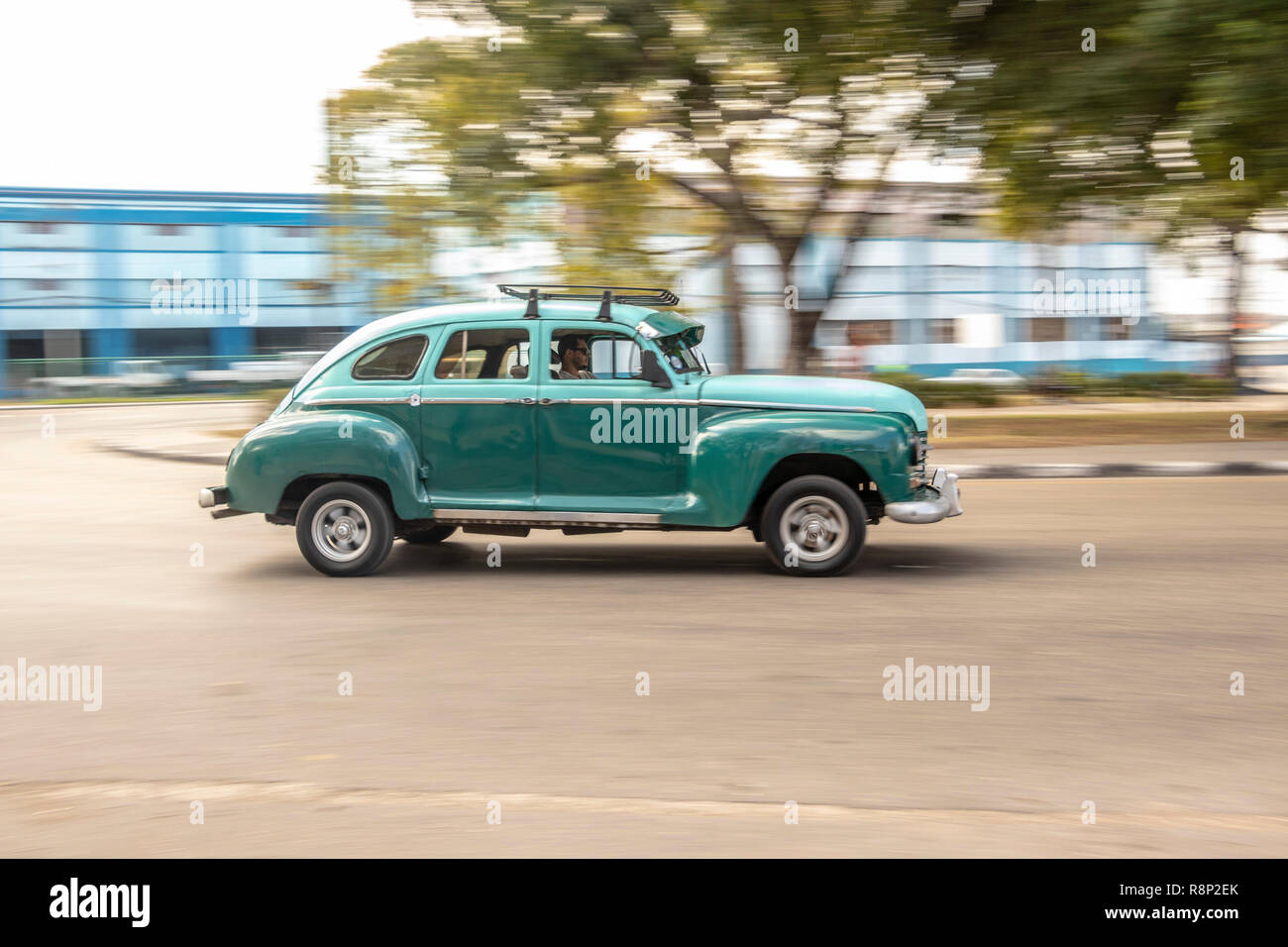 vintage American 1950s car driving at speed with blurred background in ...
