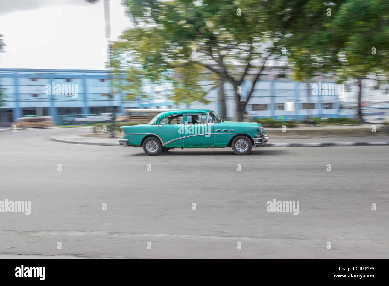 vintage American 1950s car driving at speed with blurred background in ...