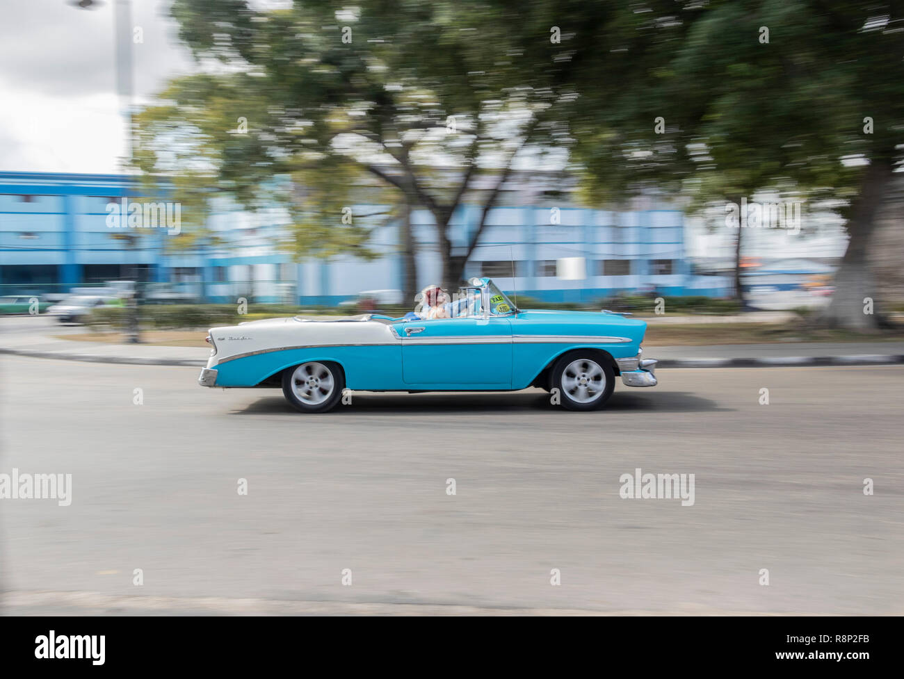 vintage American 1950s car driving at speed with blurred background in ...