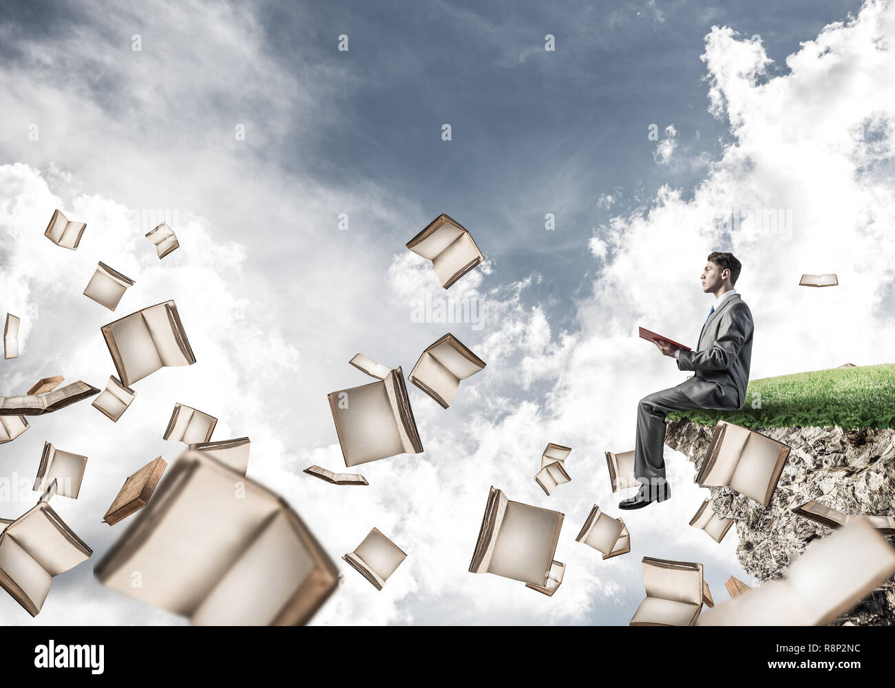 Man reading book and many of them flying in air Stock Photo - Alamy