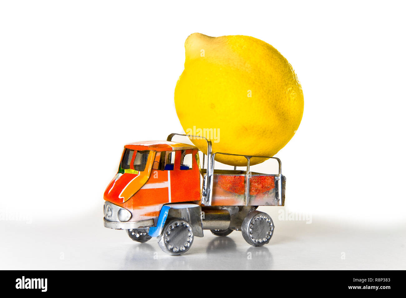Small lorry loaded with one big lemon - concept image Stock Photo - Alamy