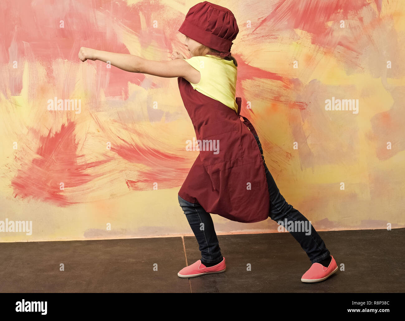 Cooking, playing, sport, fitness, energy. Kid cook practicing karate on ...